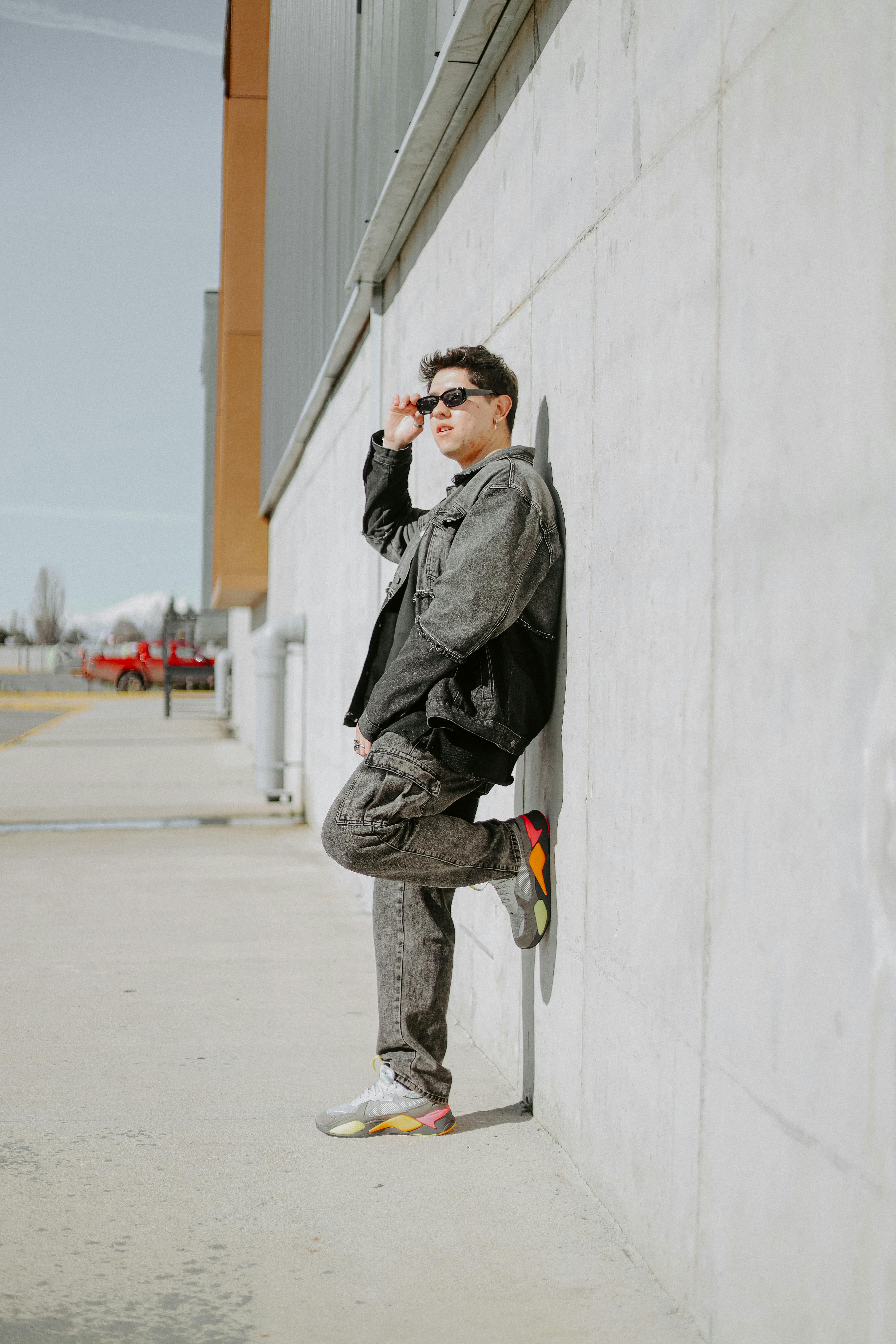 Man Standing by Sunlit Wall · Free Stock Photo