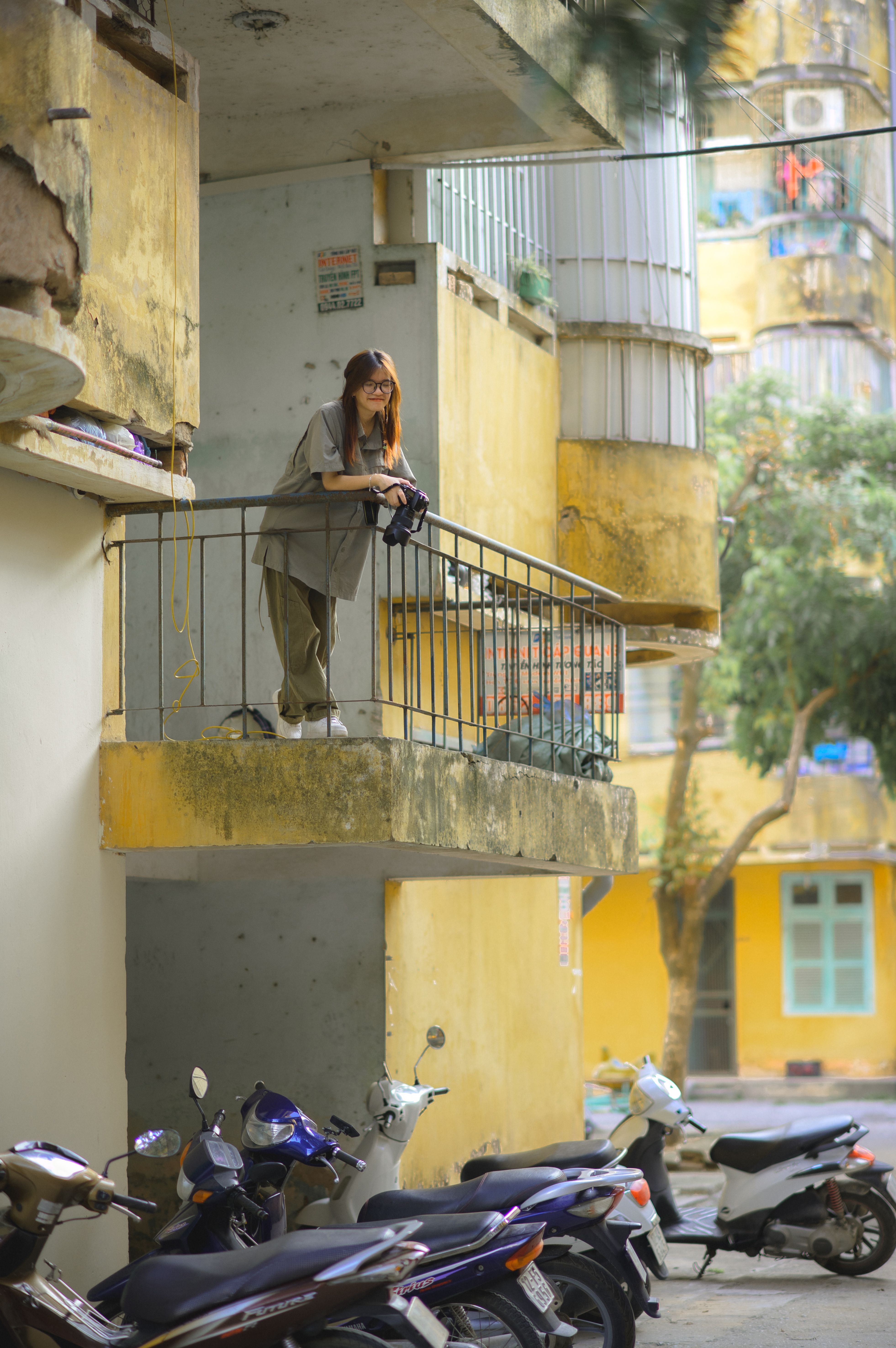 Woman with Camera on Balcony · Free Stock Photo