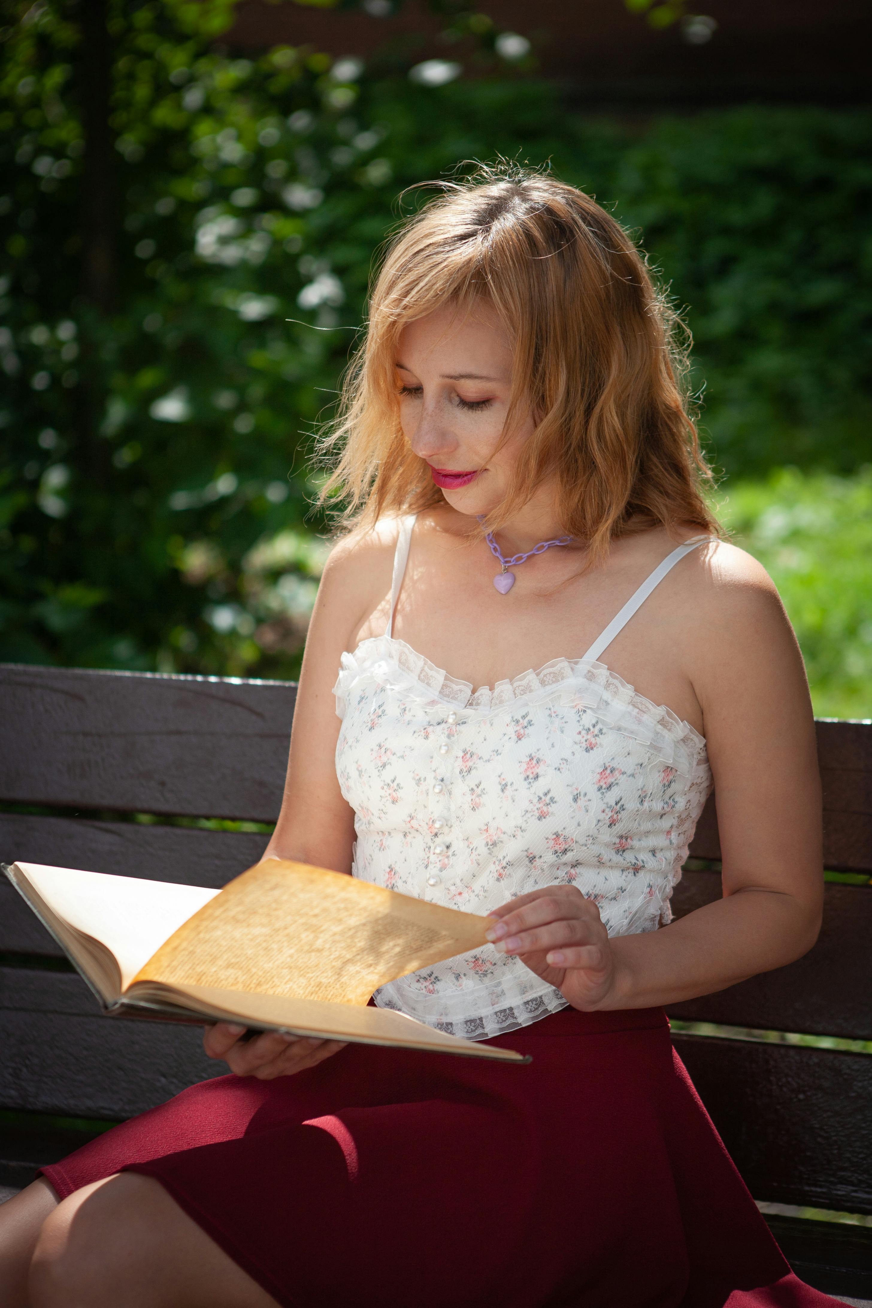 Woman Reading and Drinking Water · Free Stock Photo