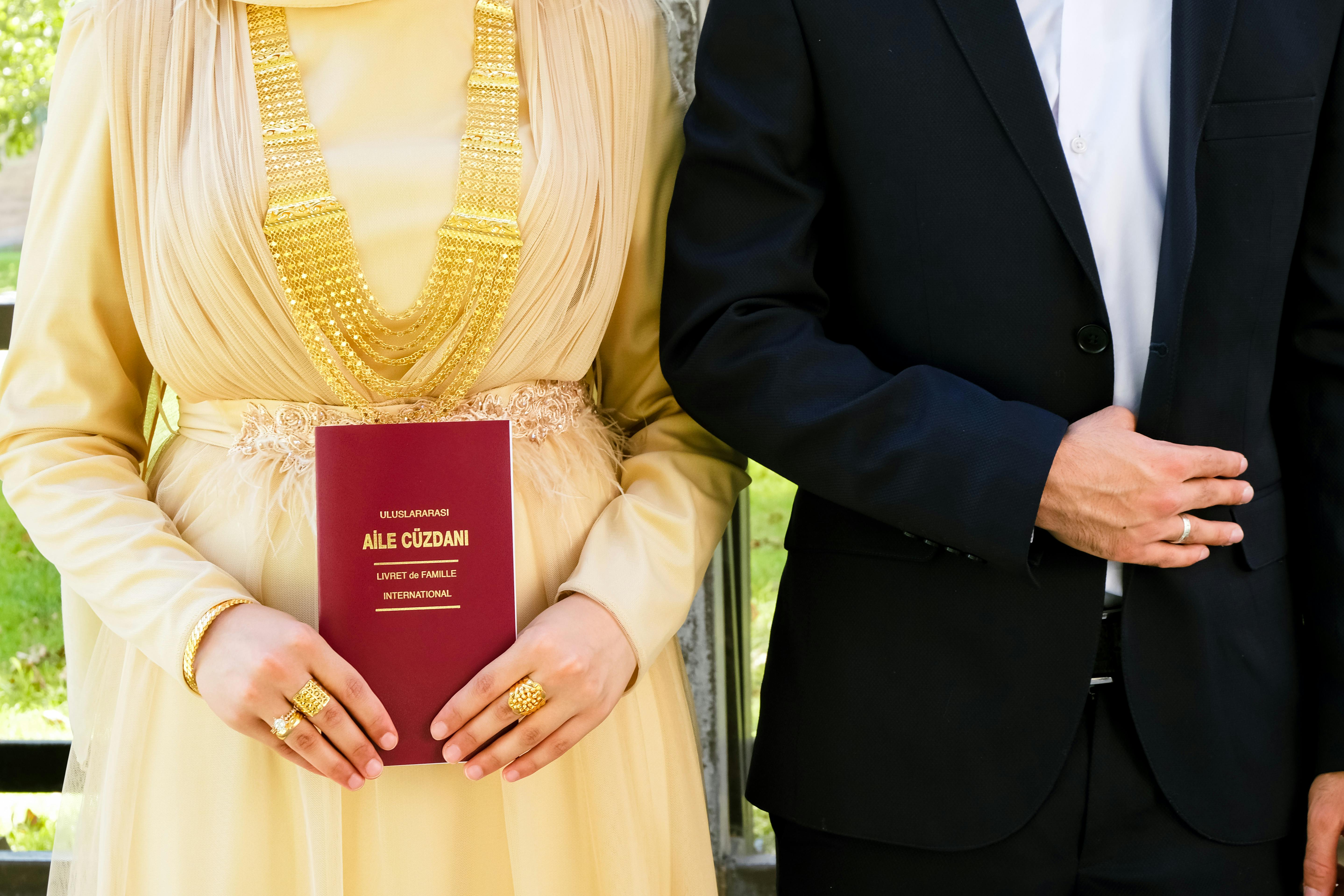 Newlyweds Standing with Turkish Marriage Certificate · Free Stock Photo