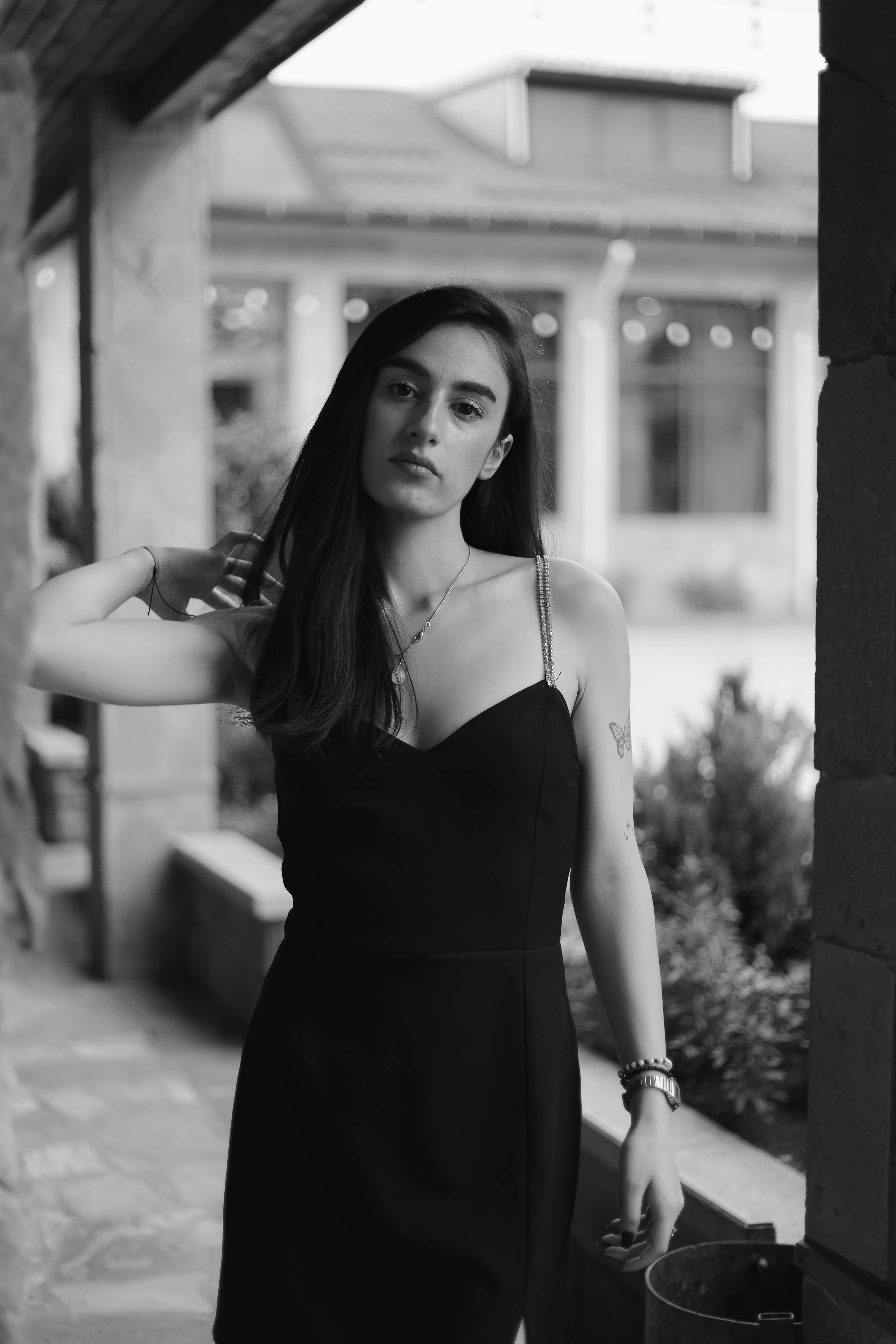 Woman in Black Bodycone Dress with Spaghetti Straps Standing on Grass ...