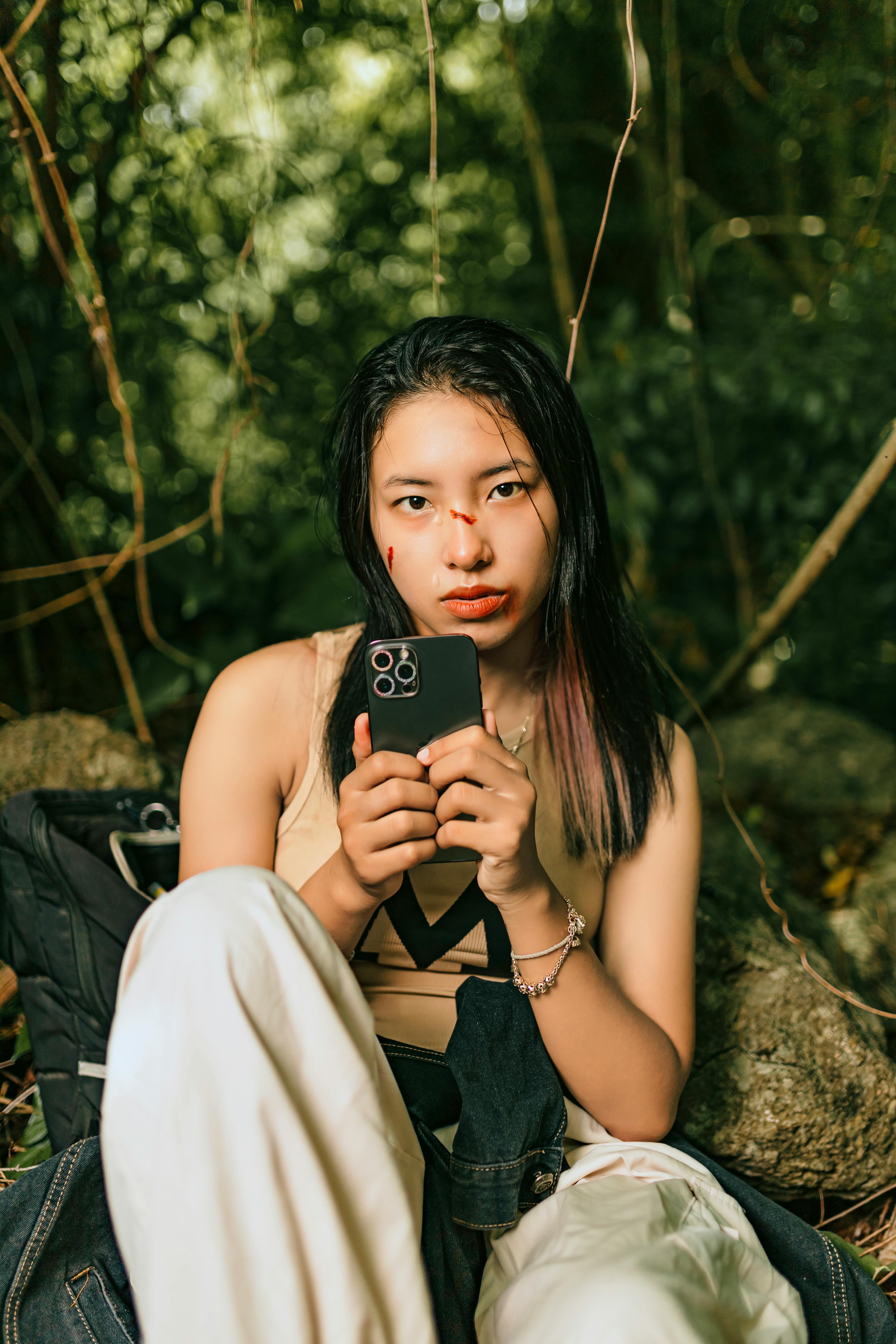 Woman with Wound on Face Holding Smartphone · Free Stock Photo