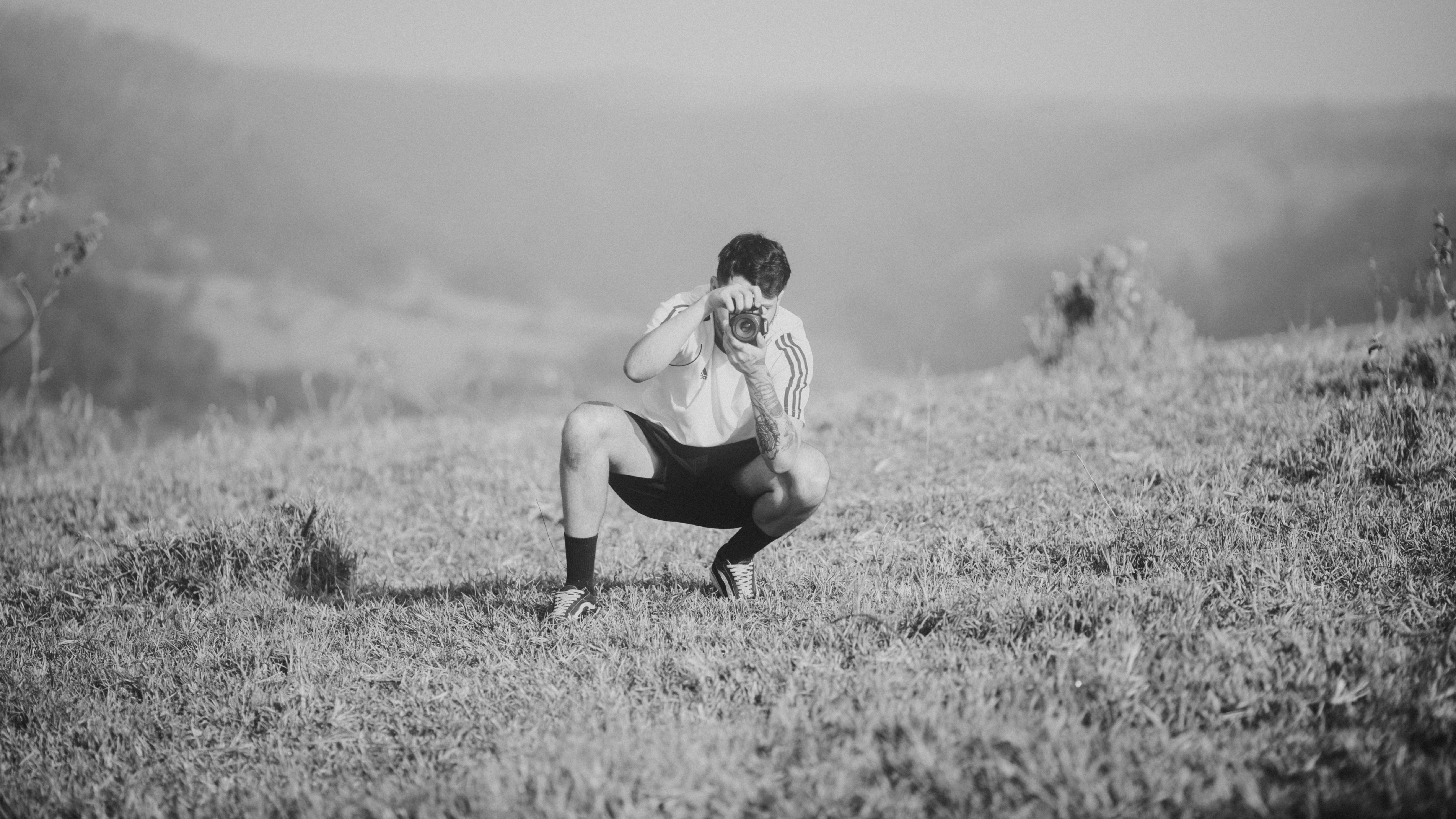Crouching Man Taking a Photo · Free Stock Photo
