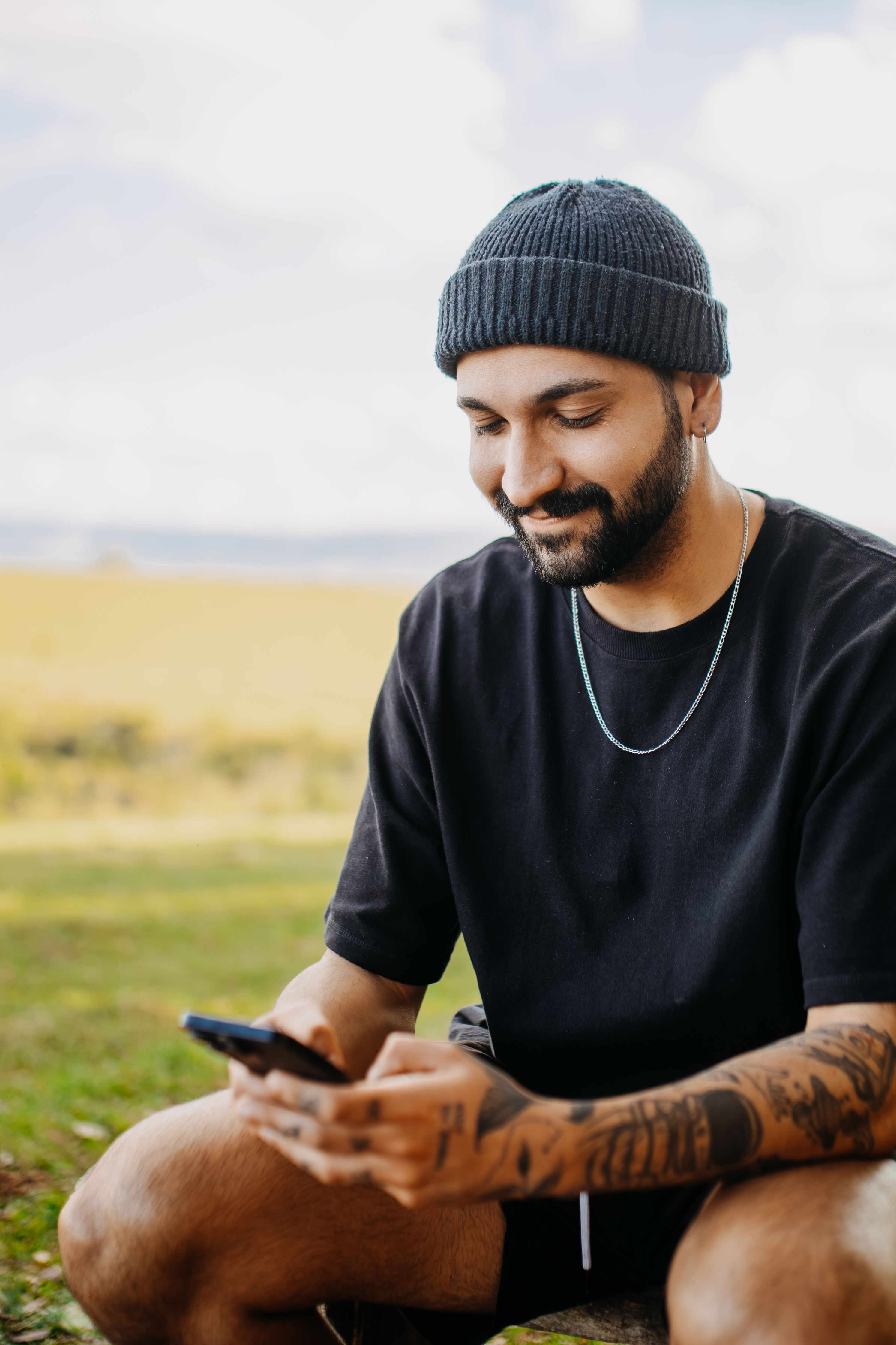 Portrait of a Man Sitting Outdoors with a Smart Phone in Hands · Free ...