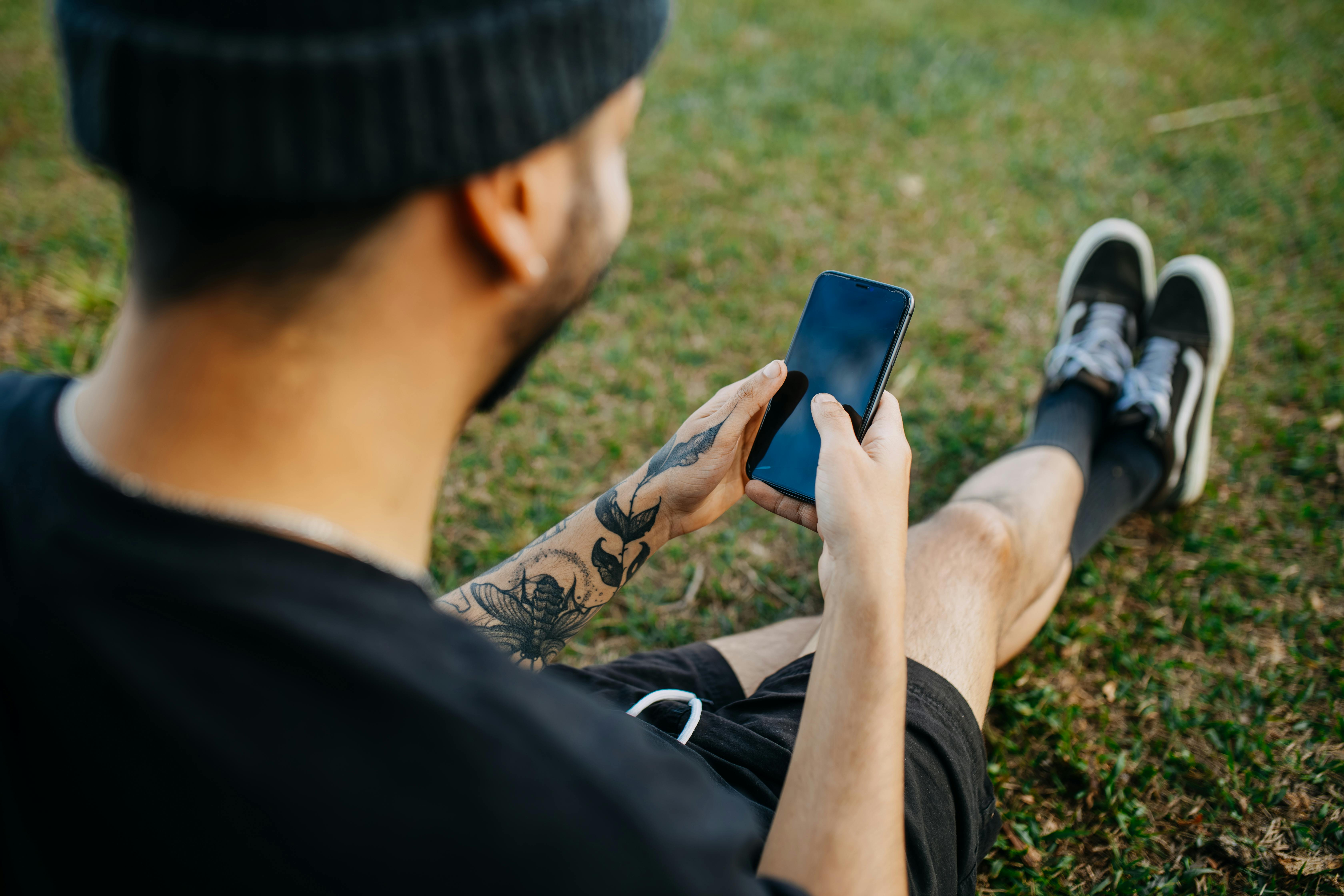 Young Woman Looking at Smartphone · Free Stock Photo