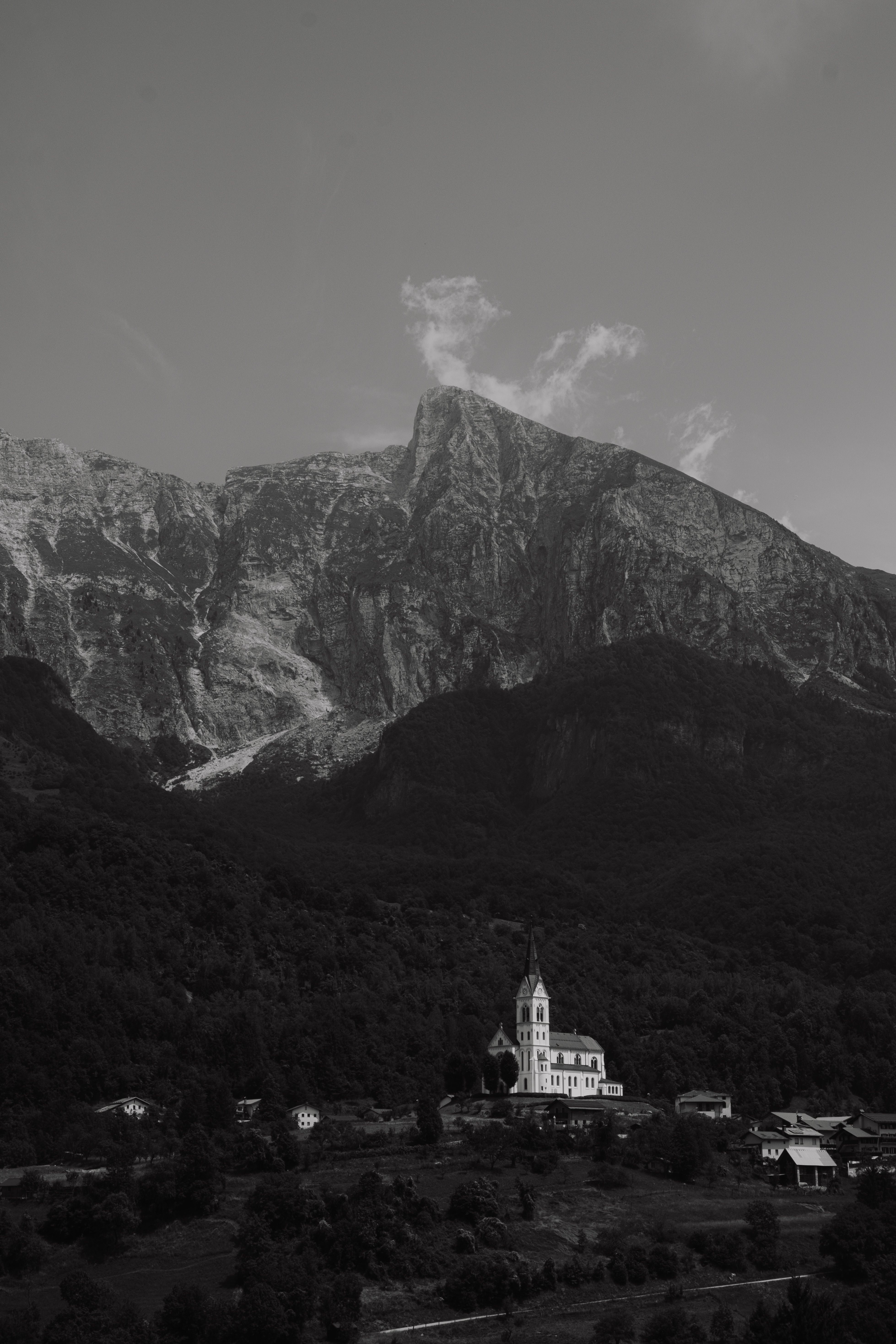 View of a Rocky Mountain and a Church in the Valley · Free Stock Photo