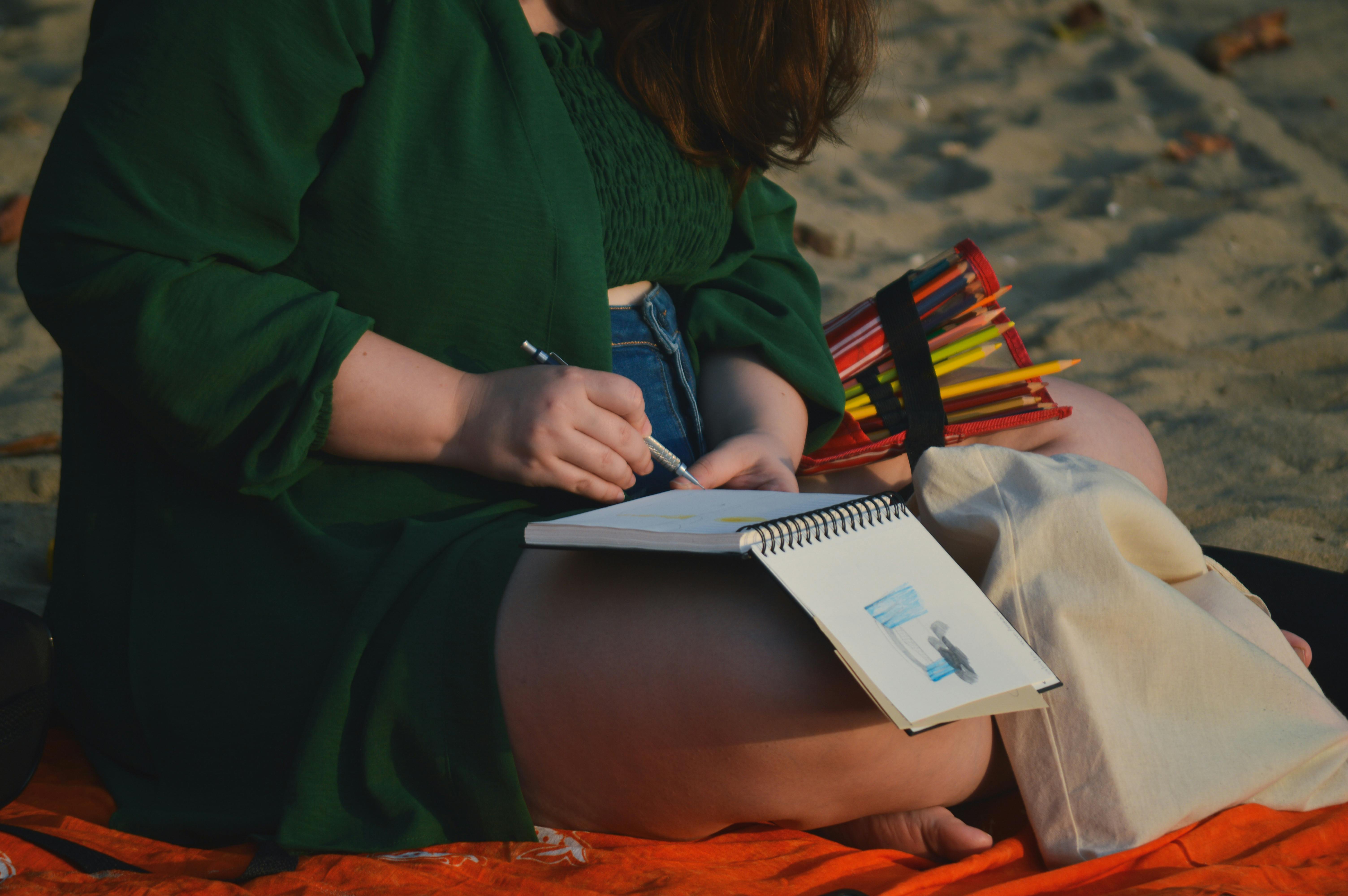 Woman Sitting on the Beach and Drawing · Free Stock Photo