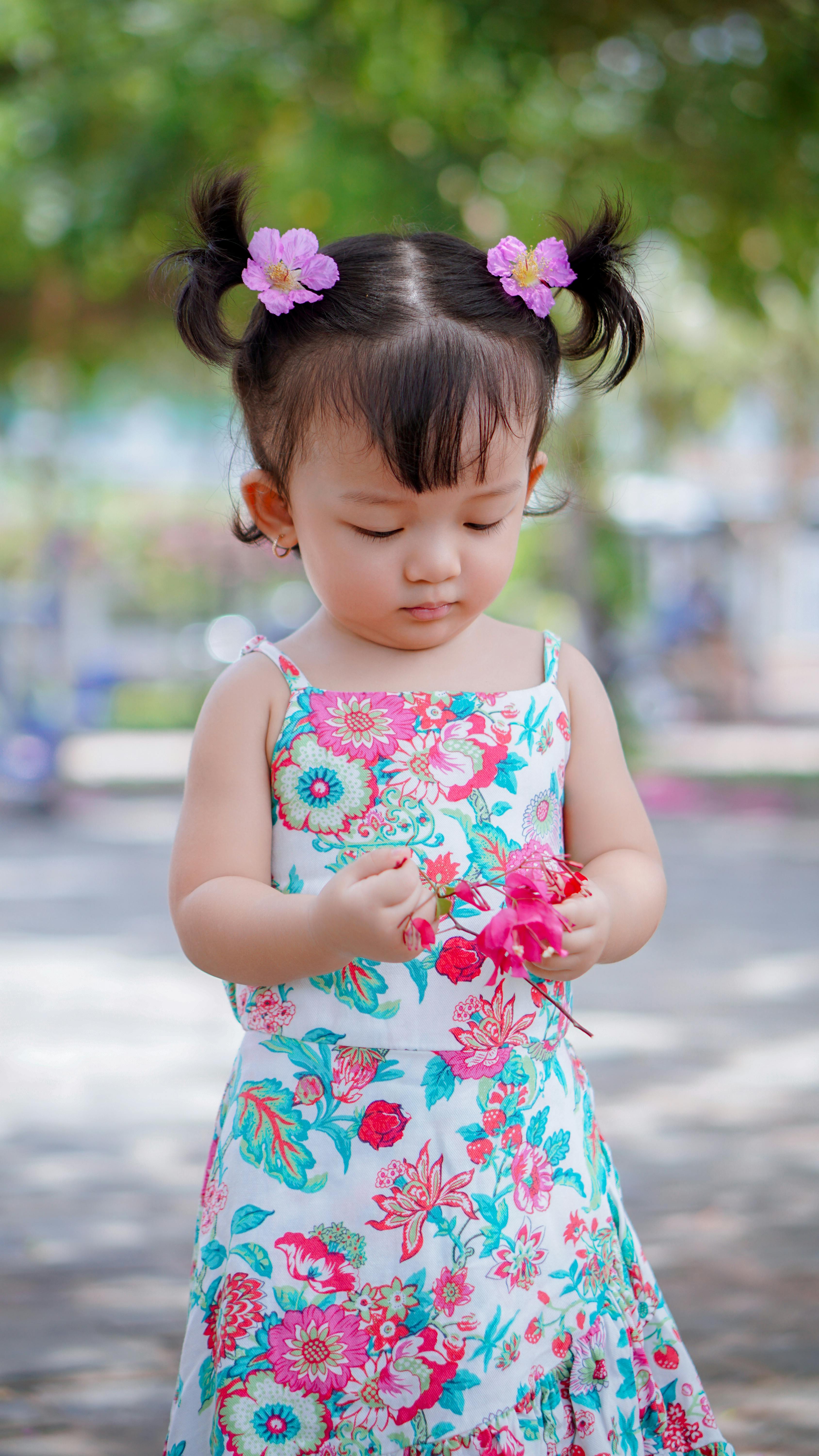 Little Girl with Tree Branch in Park · Free Stock Photo
