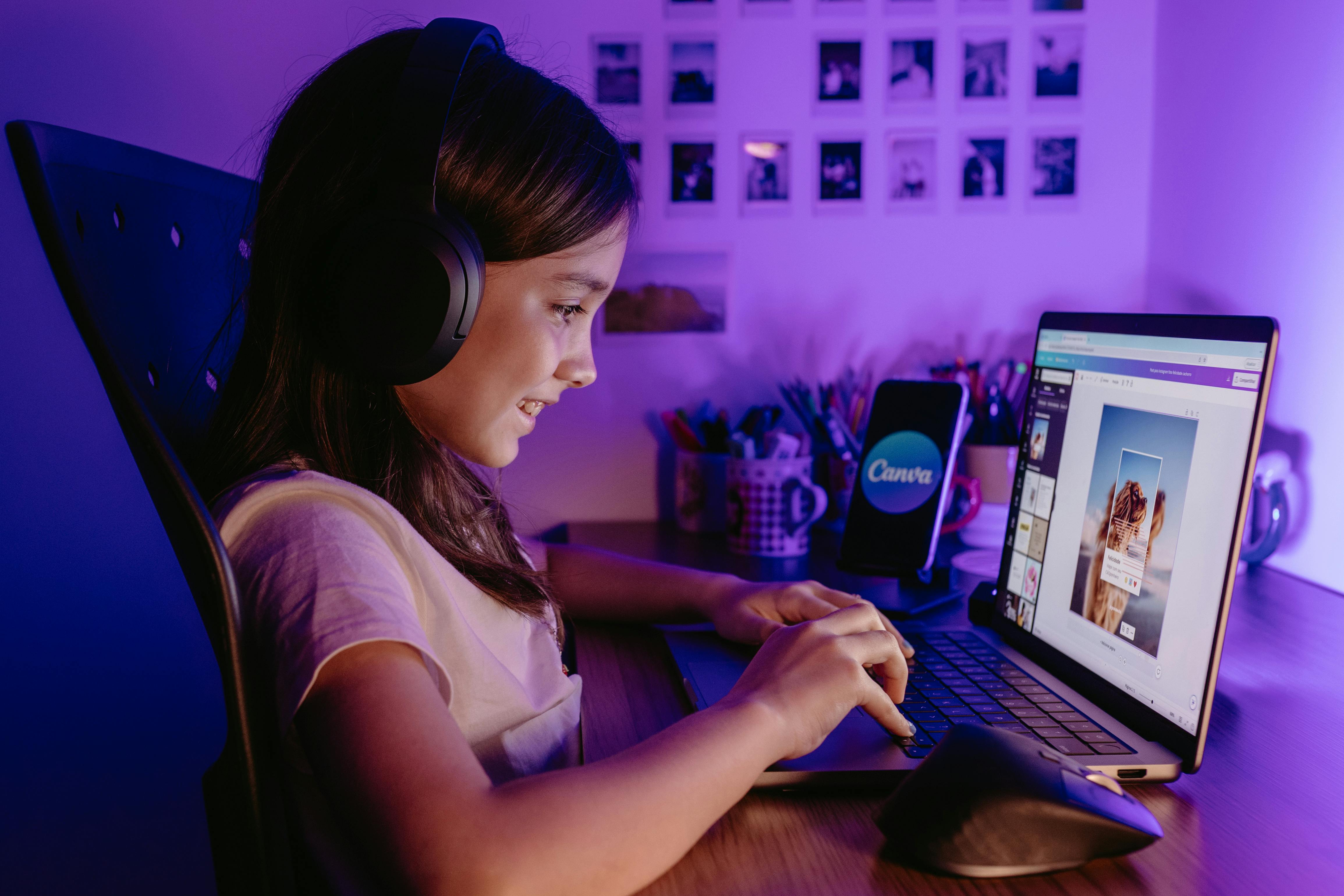 A Young Girl Editing Pictures in Canva on Her Laptop · Free Stock Photo