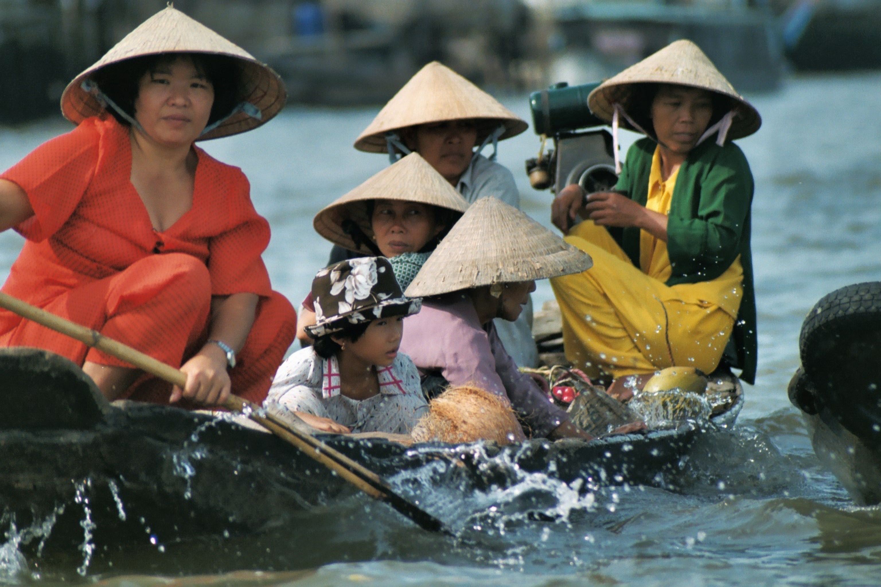 People Wearing Conical Hats on a Boat · Free Stock Photo