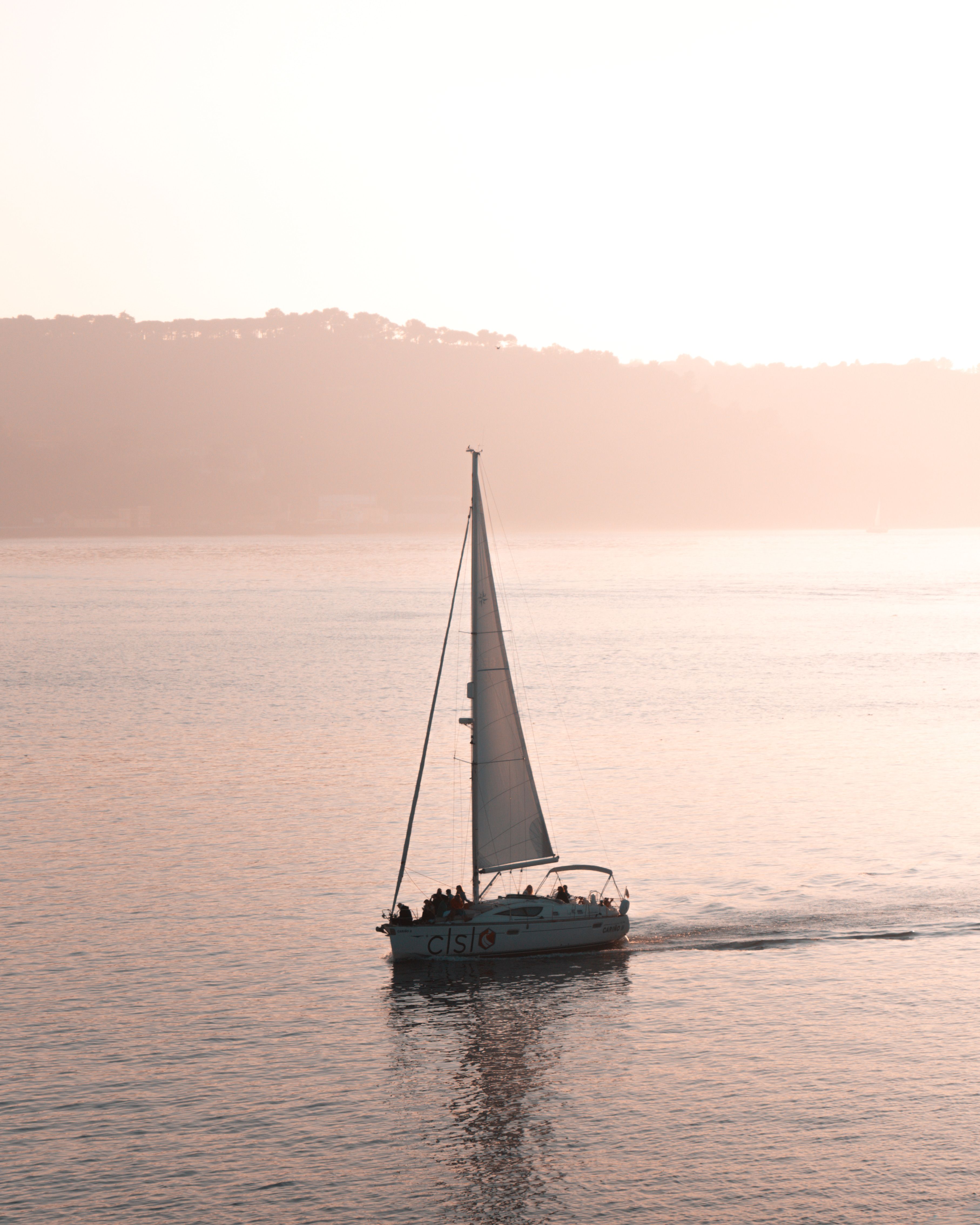 Sunset Sunlight over Sailboat on Sea Coast · Free Stock Photo