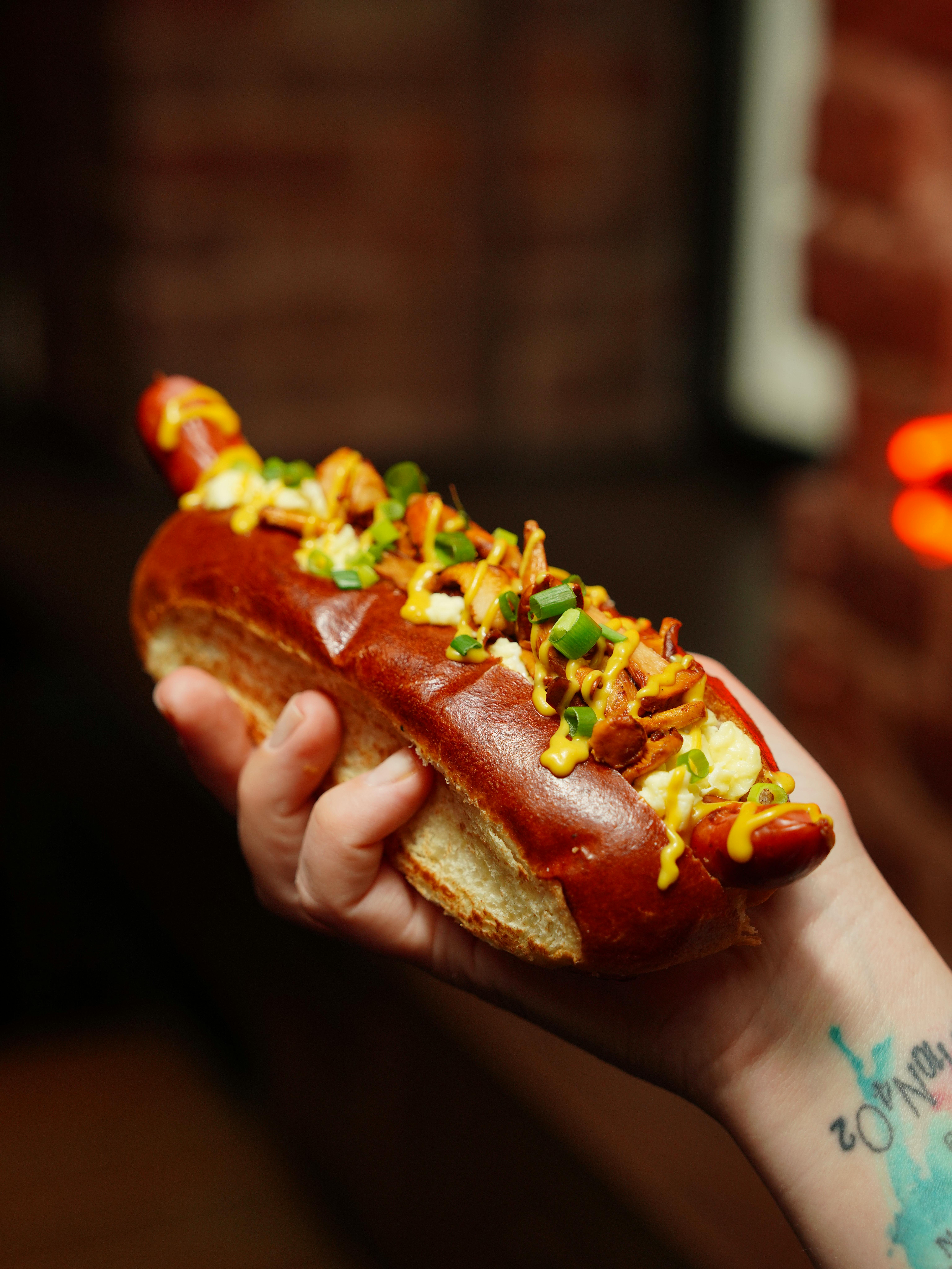 Close-up of a Woman Holding a Hot Dog · Free Stock Photo