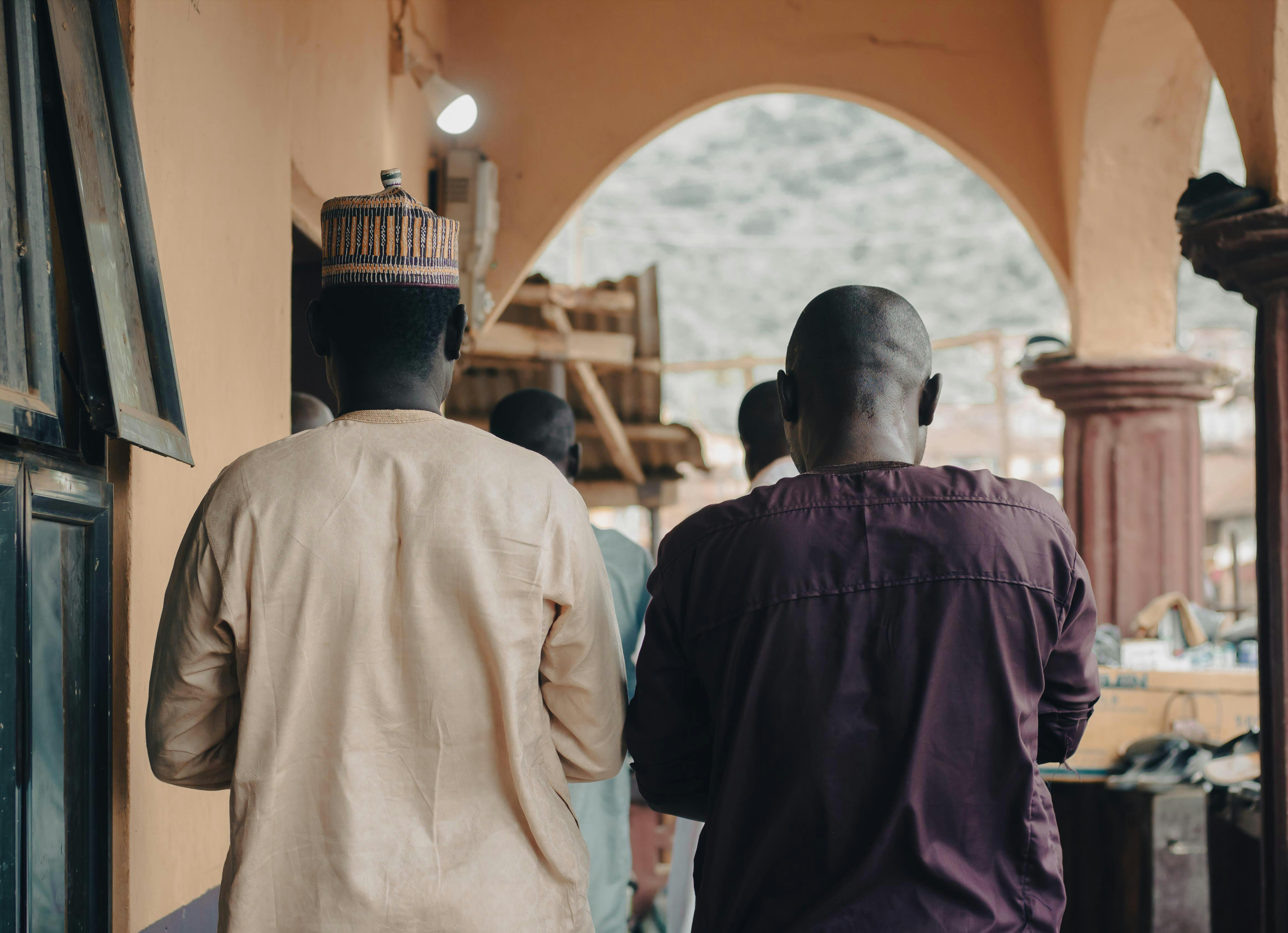 Back View of Men in Traditional Clothing · Free Stock Photo