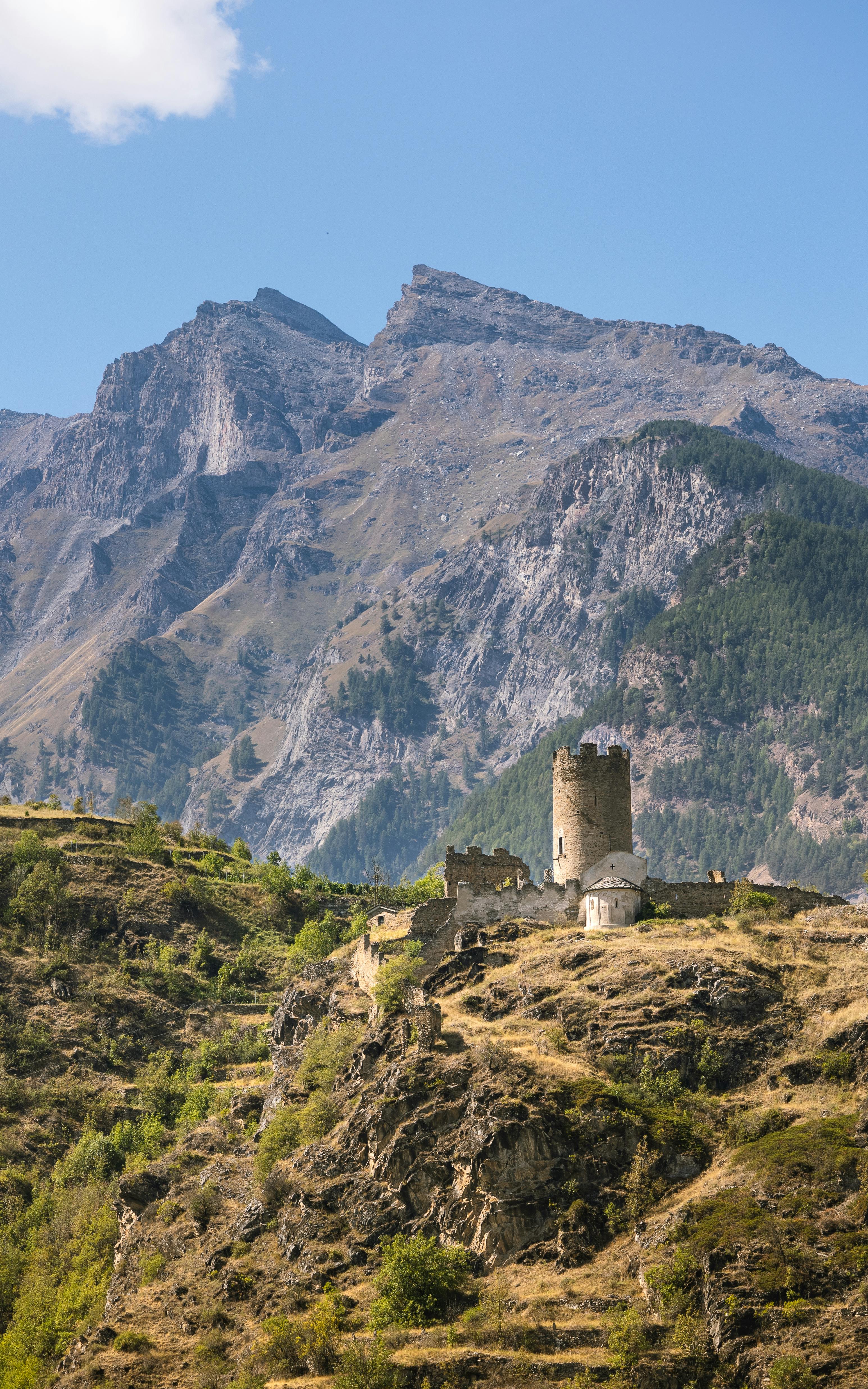Fortification Ruins on Hill with Mountain behind · Free Stock Photo