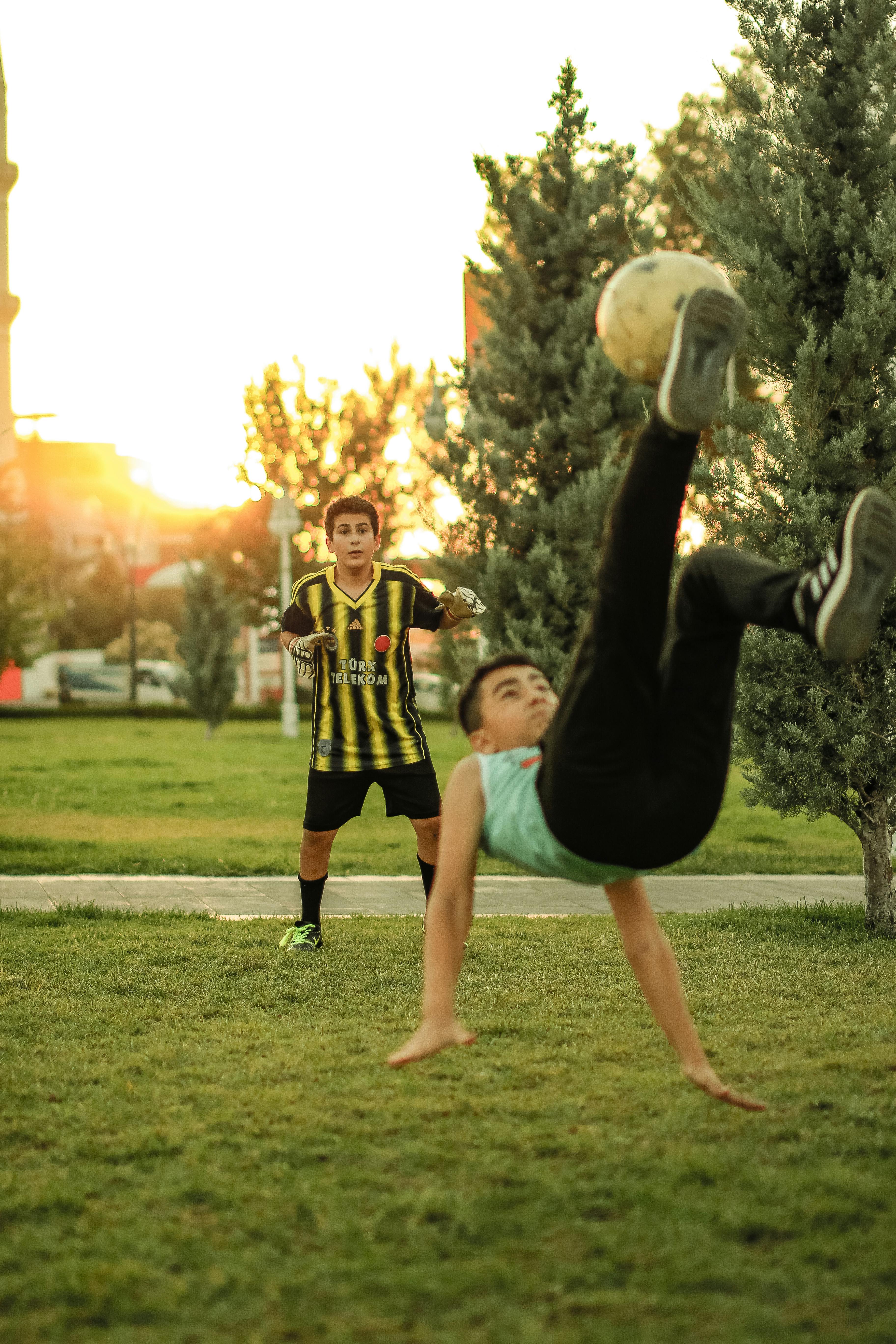 Boy Kicking Ball · Free Stock Photo