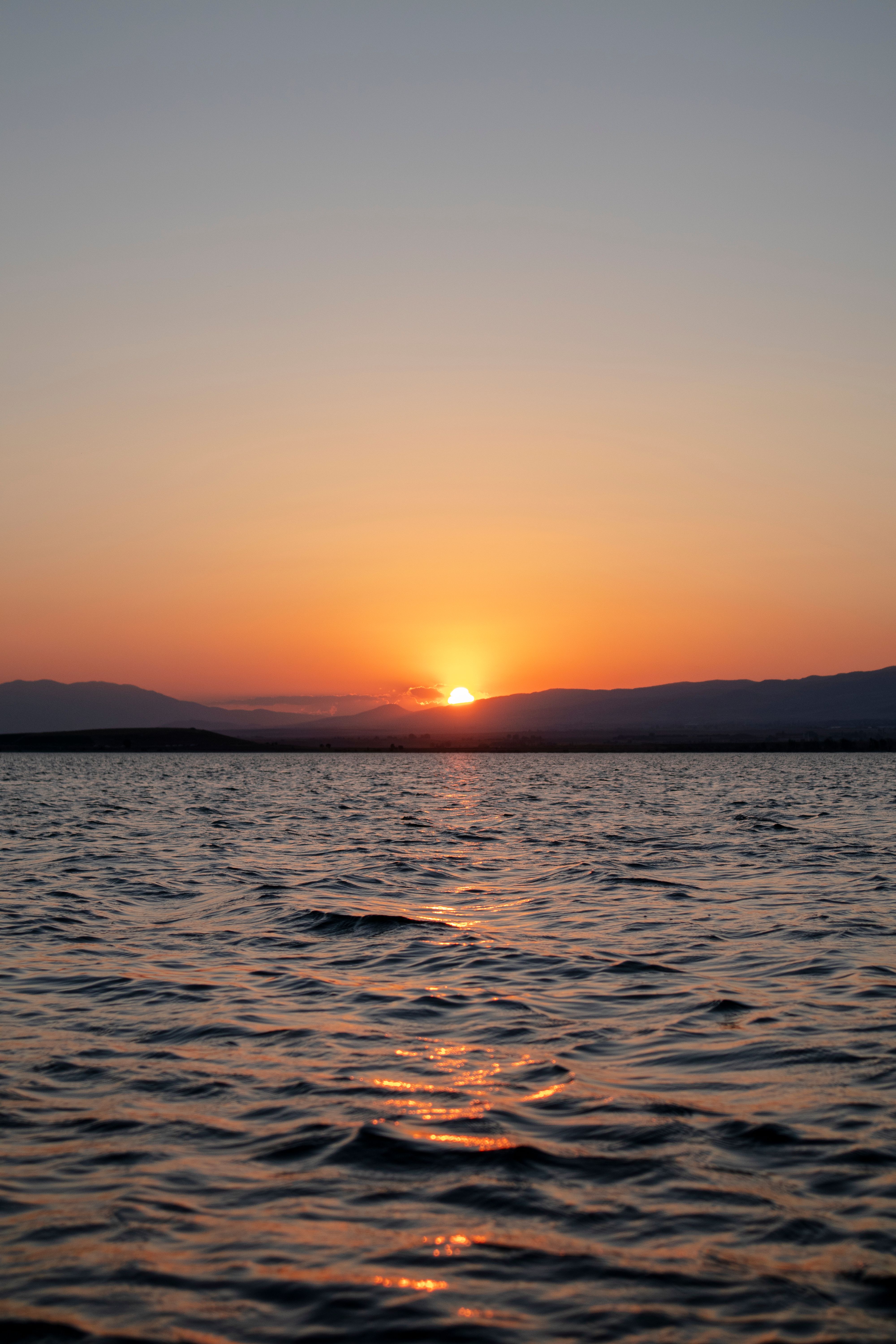 Body of Water Under Sunset · Free Stock Photo
