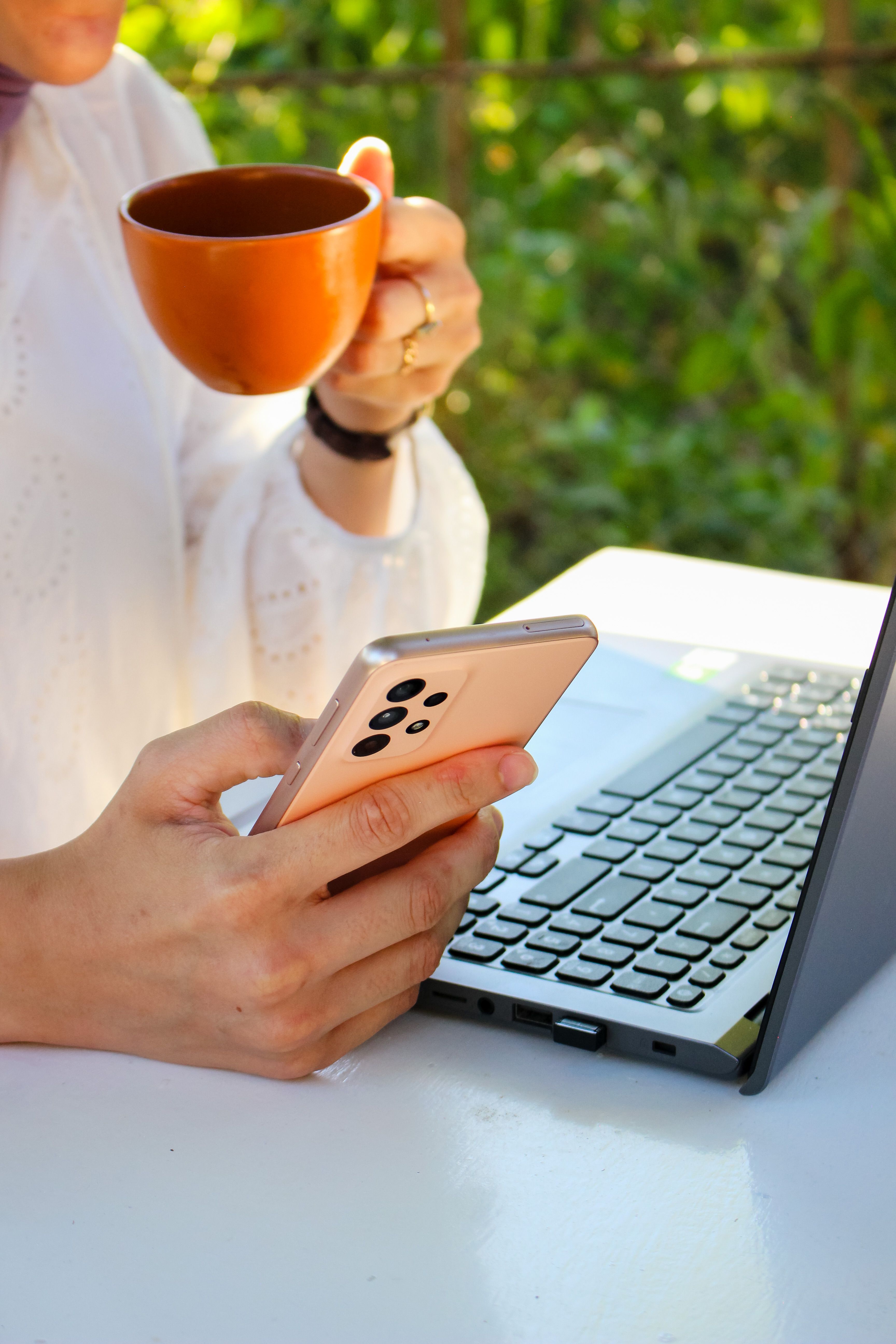 Laptop and Hand with Smartphone · Free Stock Photo