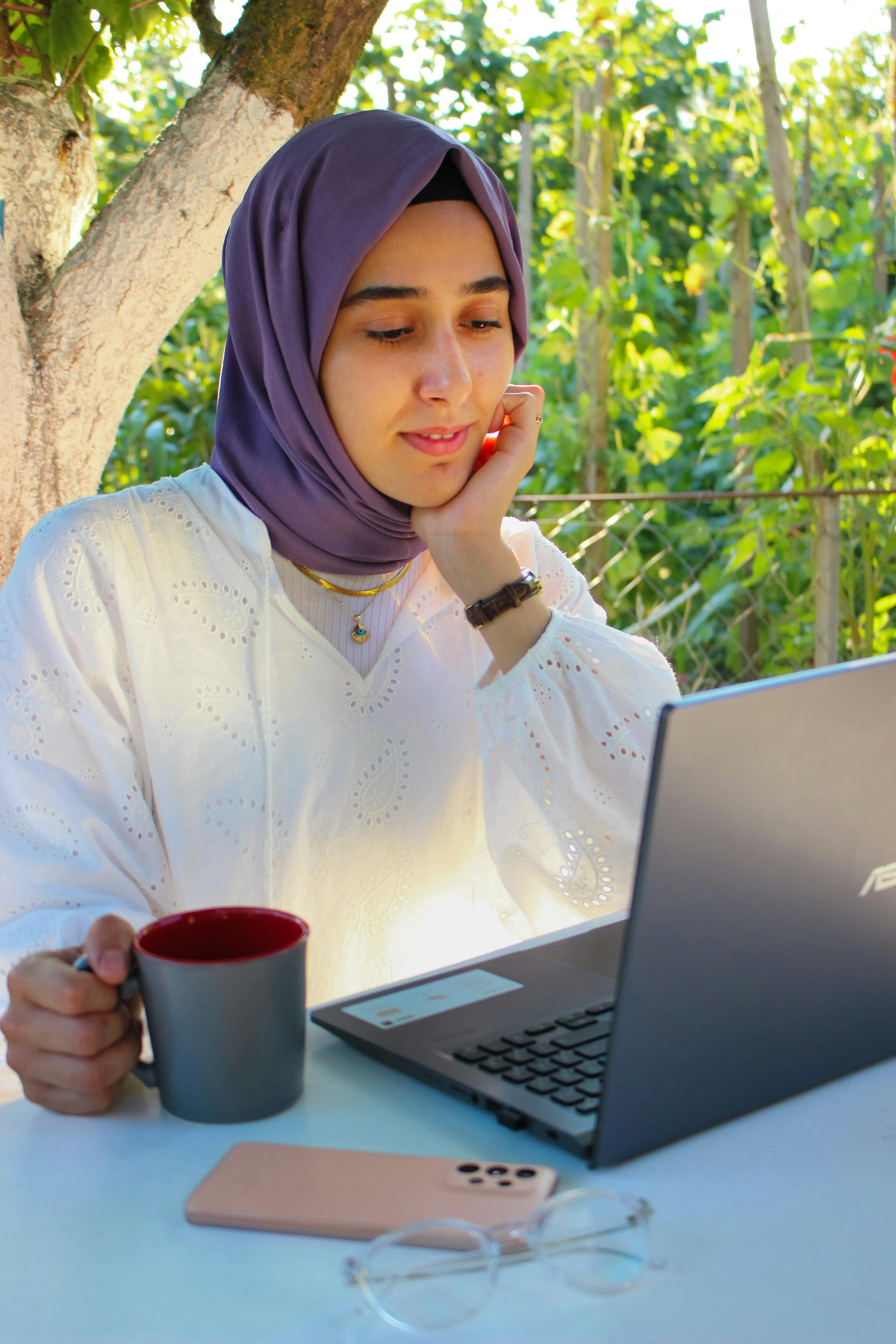 Smiling Woman Working at Computer in Yard · Free Stock Photo