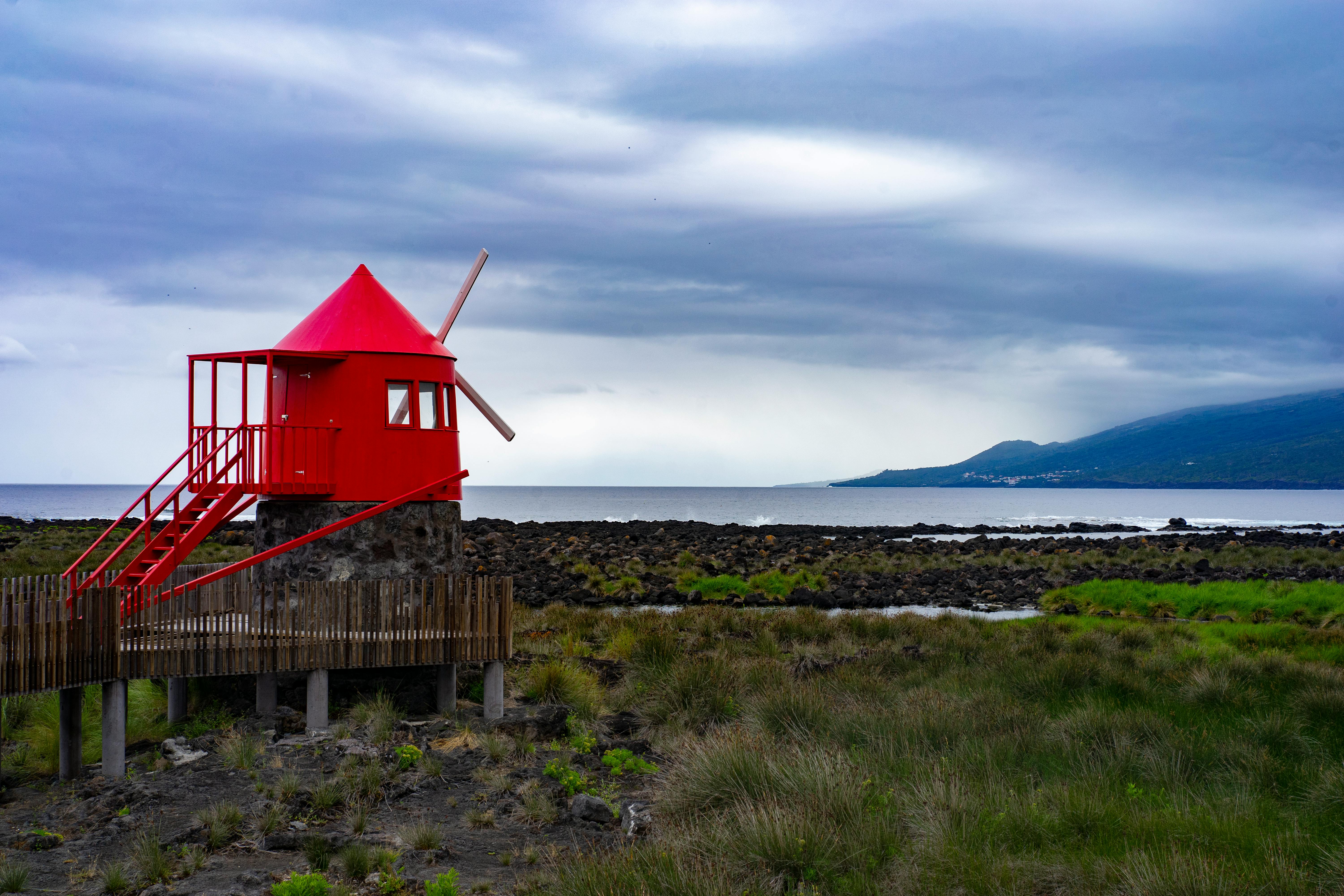 Red Lighthouse on Sea Coast · Free Stock Photo