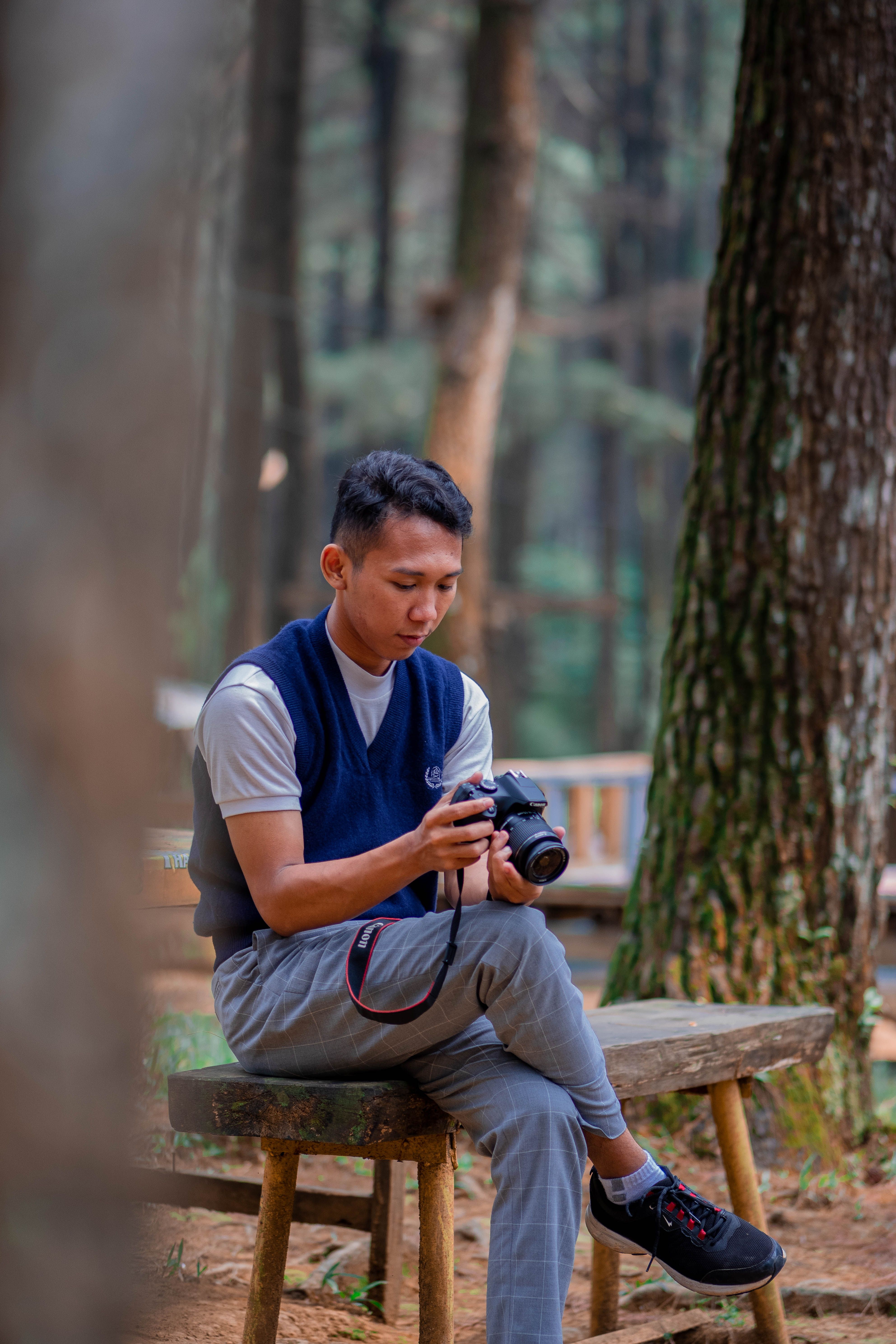 Man Sitting on Bench with Camera · Free Stock Photo