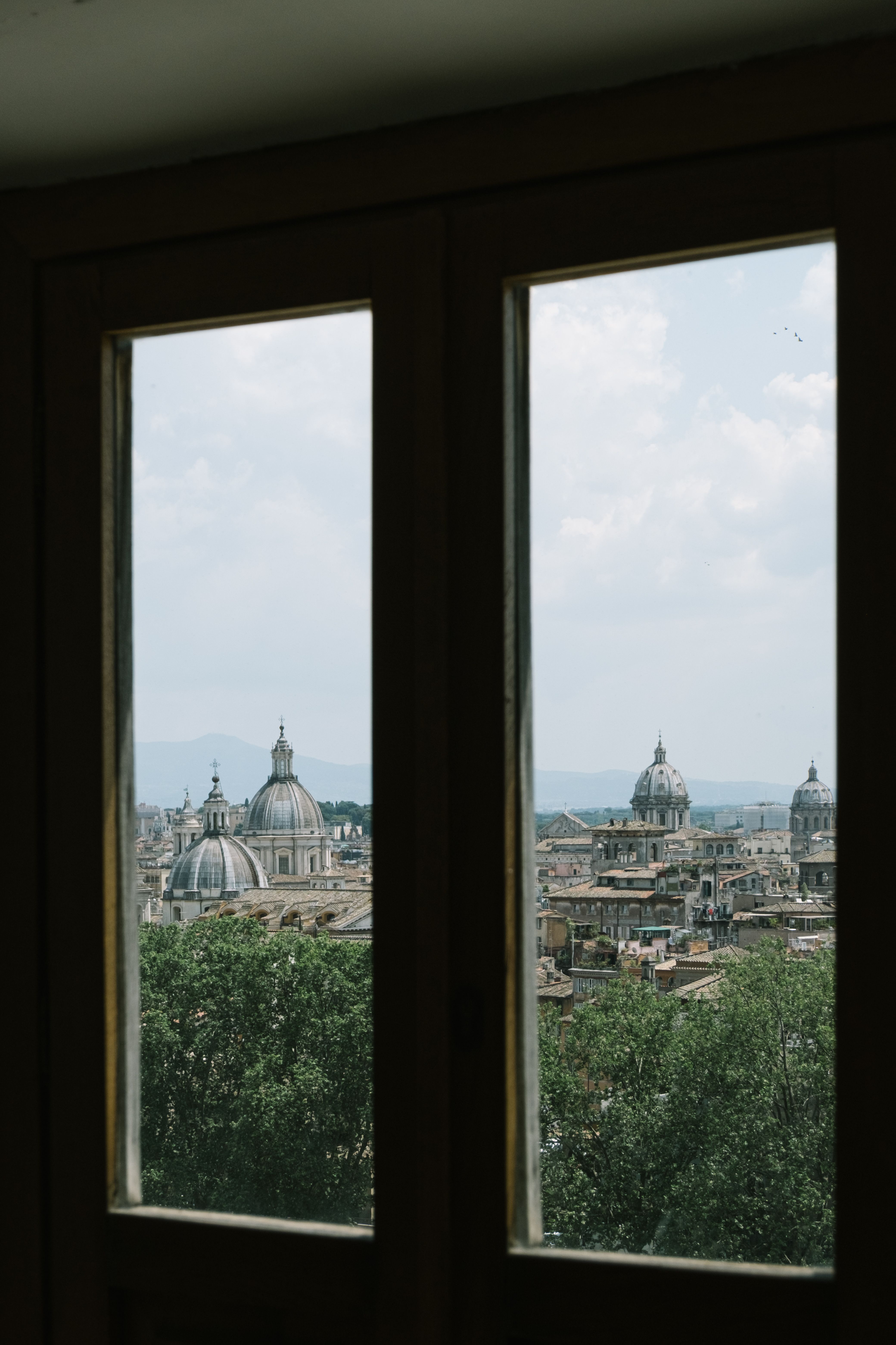 View of Domes of Buildings in Rome seen from a Window · Free Stock Photo