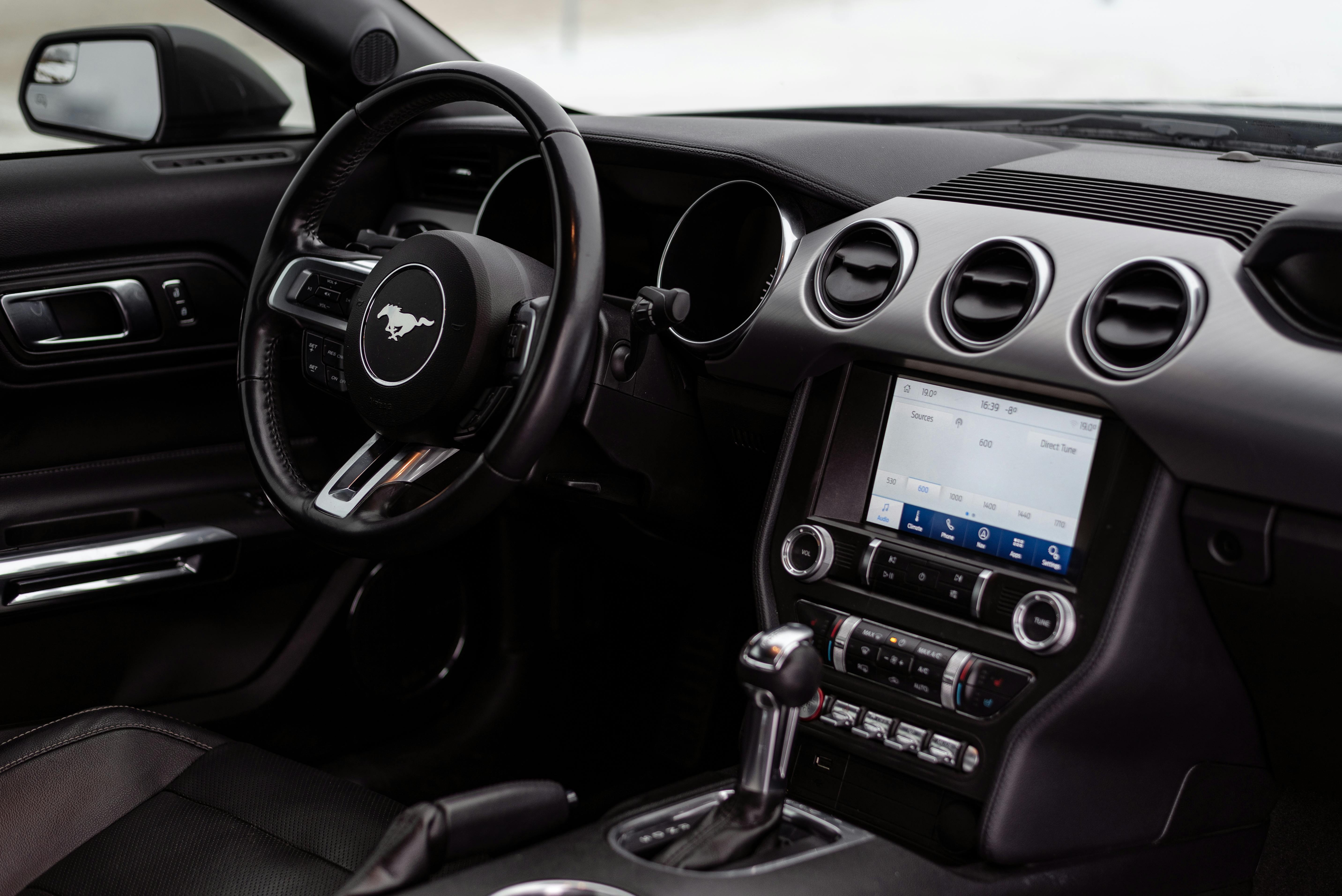 Steering Wheel and Controls of a Ford Mustang Sports Car · Free Stock Photo