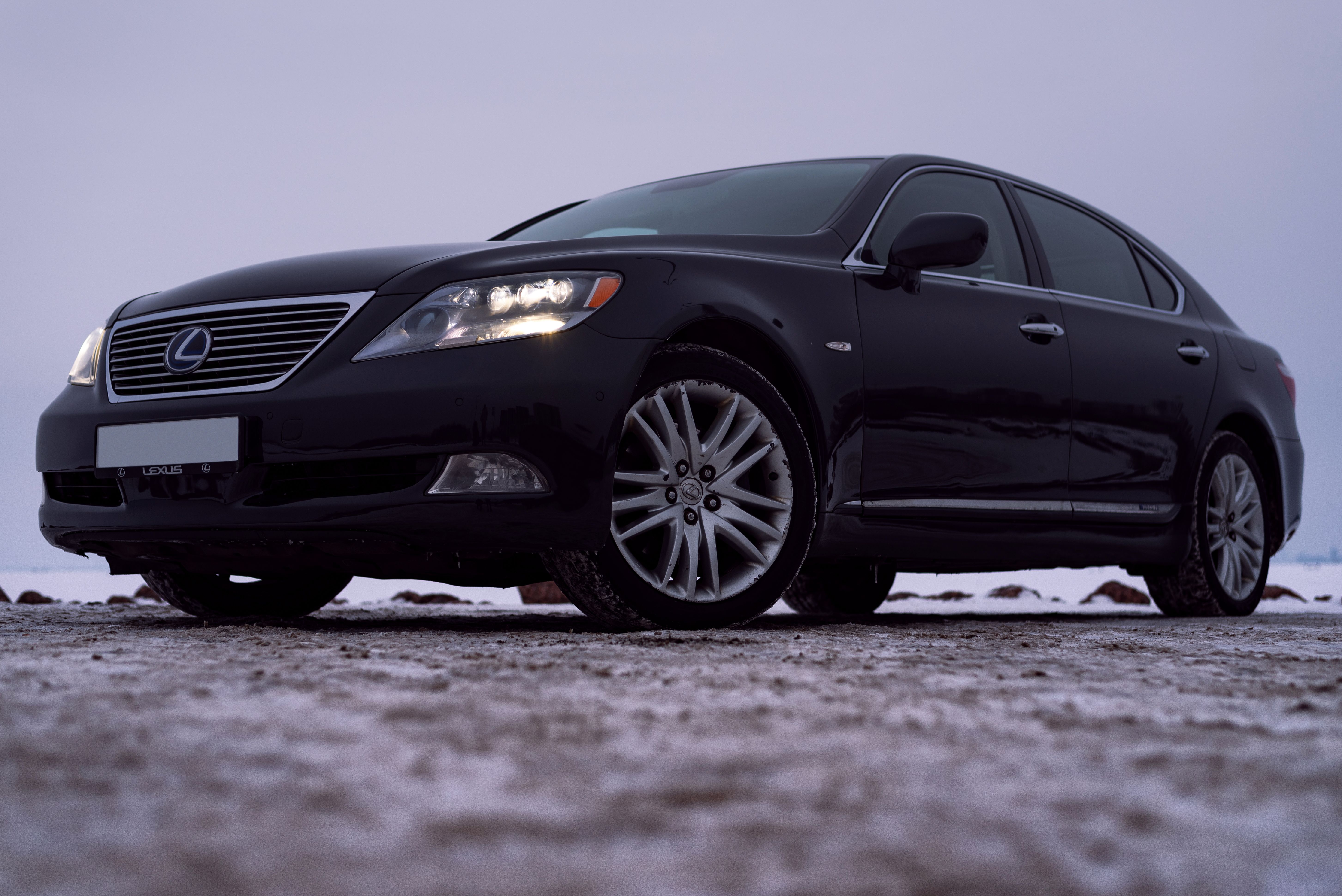 Black Lexus LS 460 Car on a Snow Covered Parking Lot · Free Stock Photo