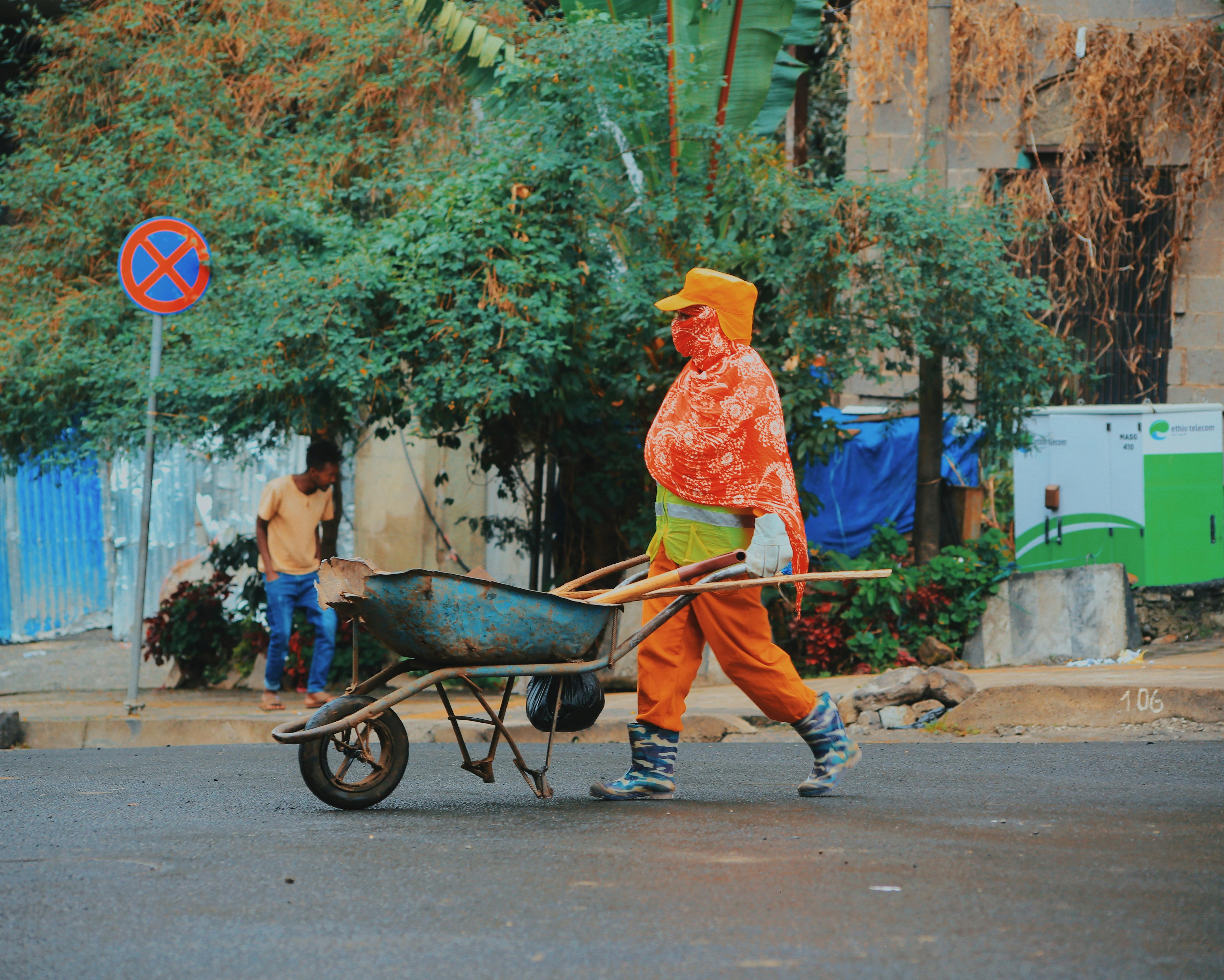 Person Pushing Wheelbarrow · Free Stock Photo