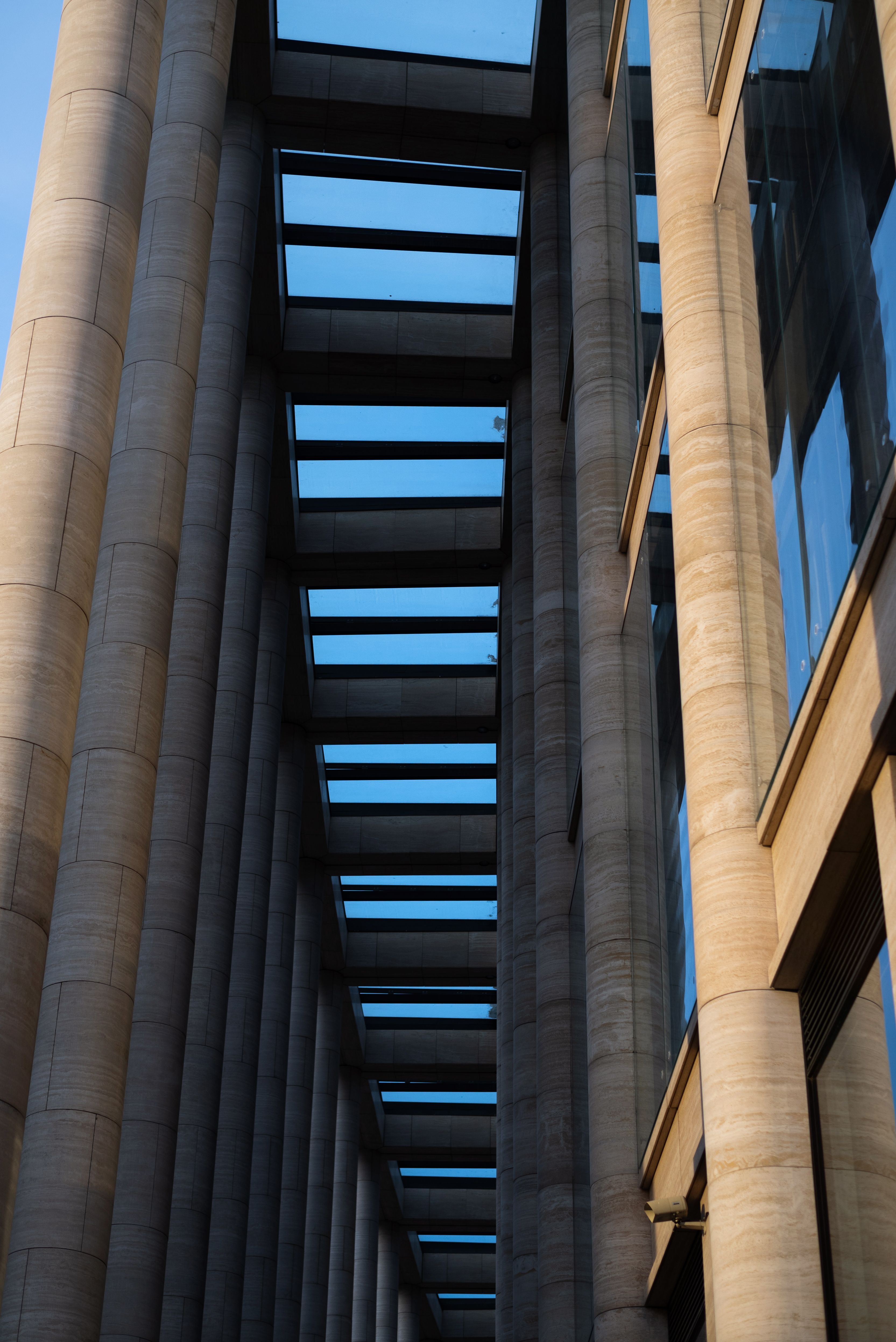 A Modern Building with Columns and Glass Ceiling · Free Stock Photo