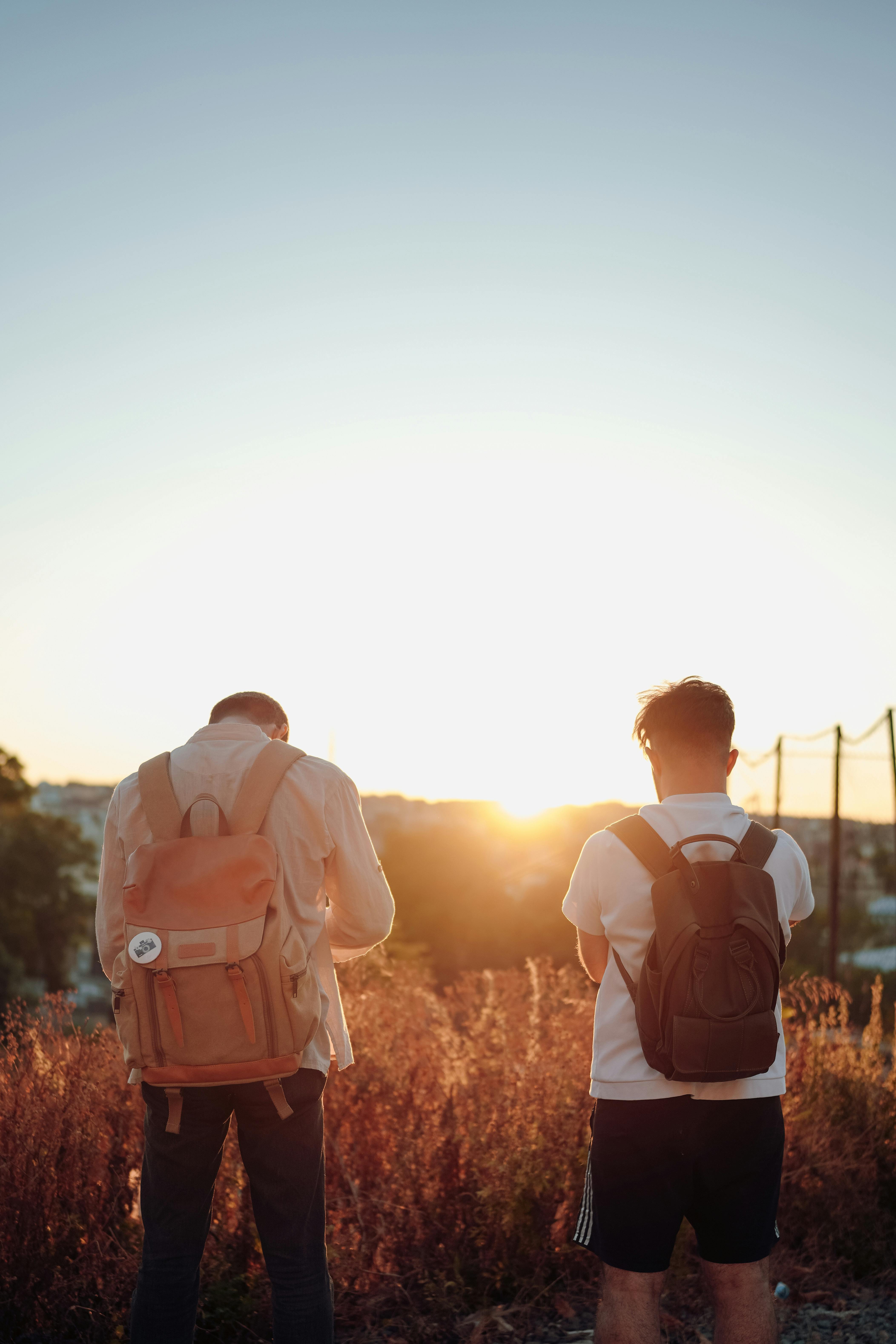Sunset Sunlight over Men with Backpacks · Free Stock Photo