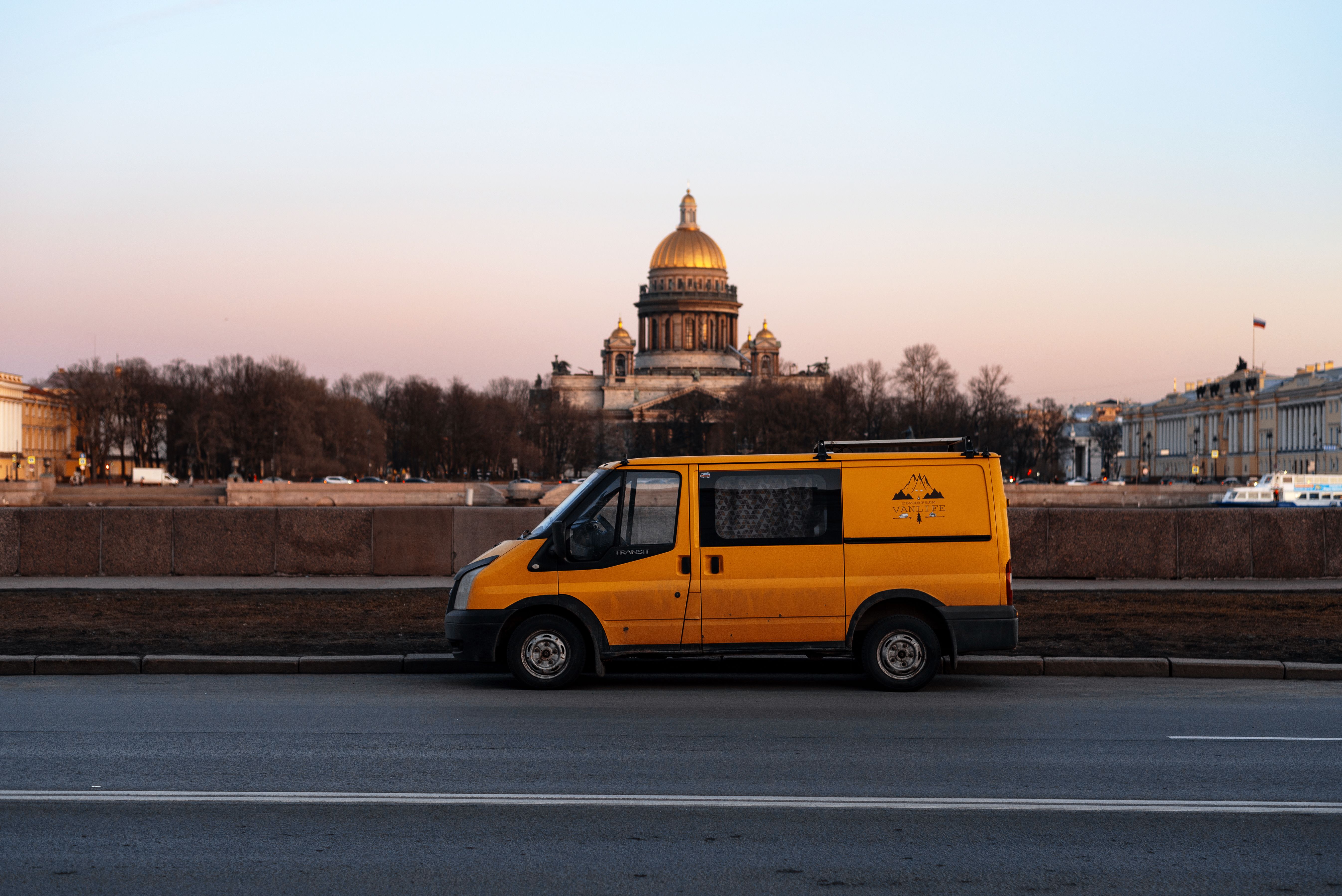 Yellow Mini Van Parked on a Street with a Cathedral in the Background ...