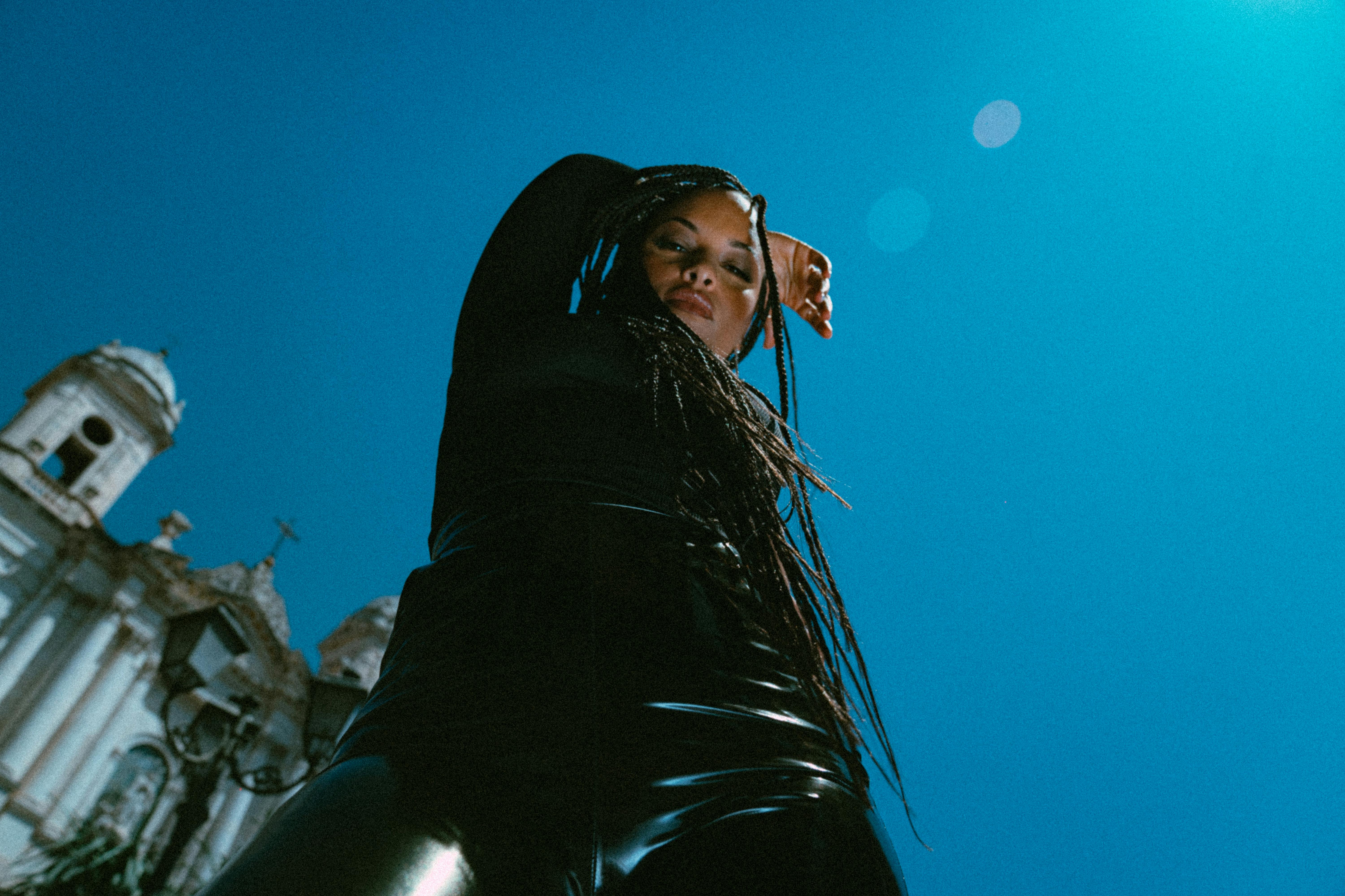 Woman in Braided Hair Standing by Church · Free Stock Photo