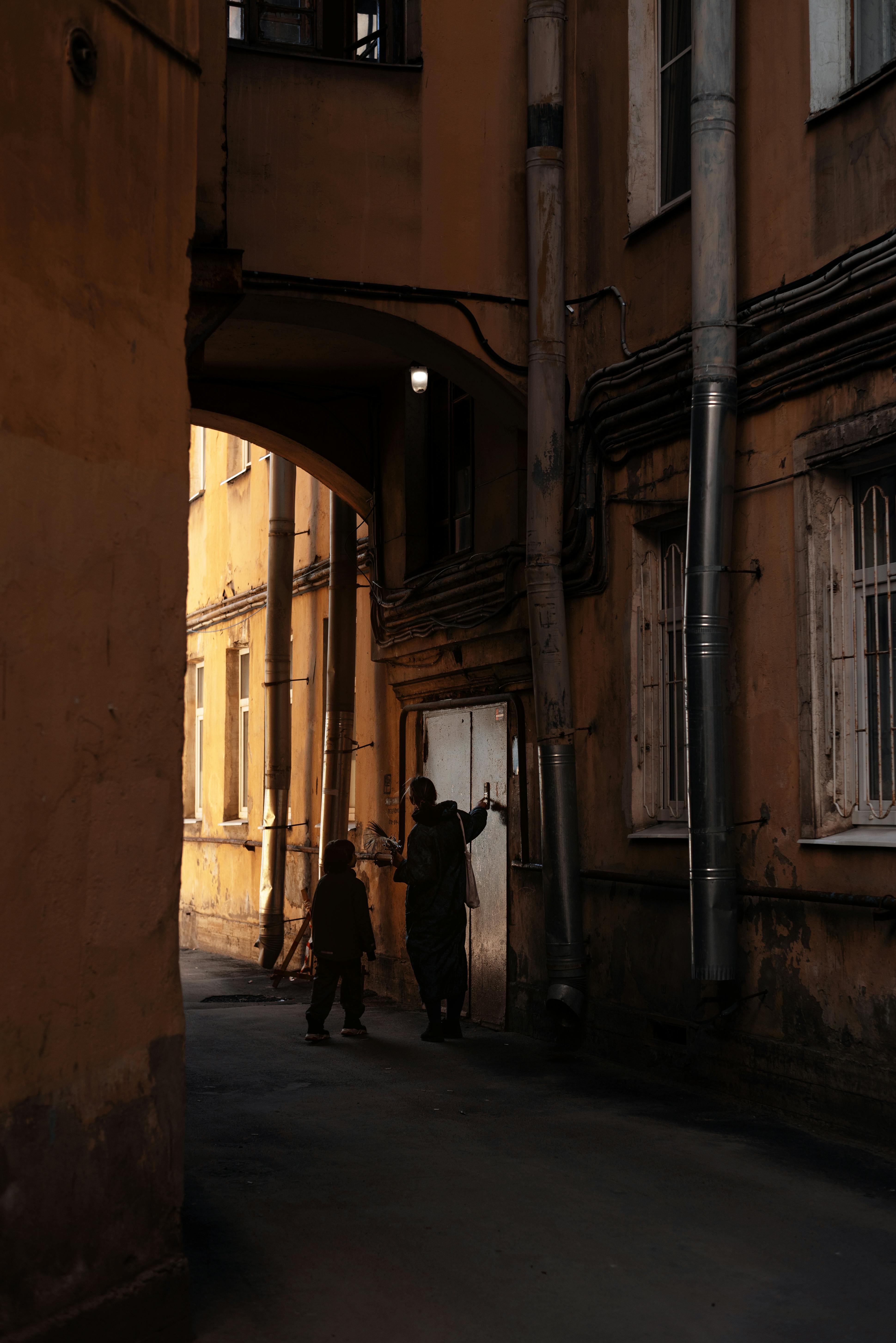 People Standing in Shadow in Alley in Town · Free Stock Photo