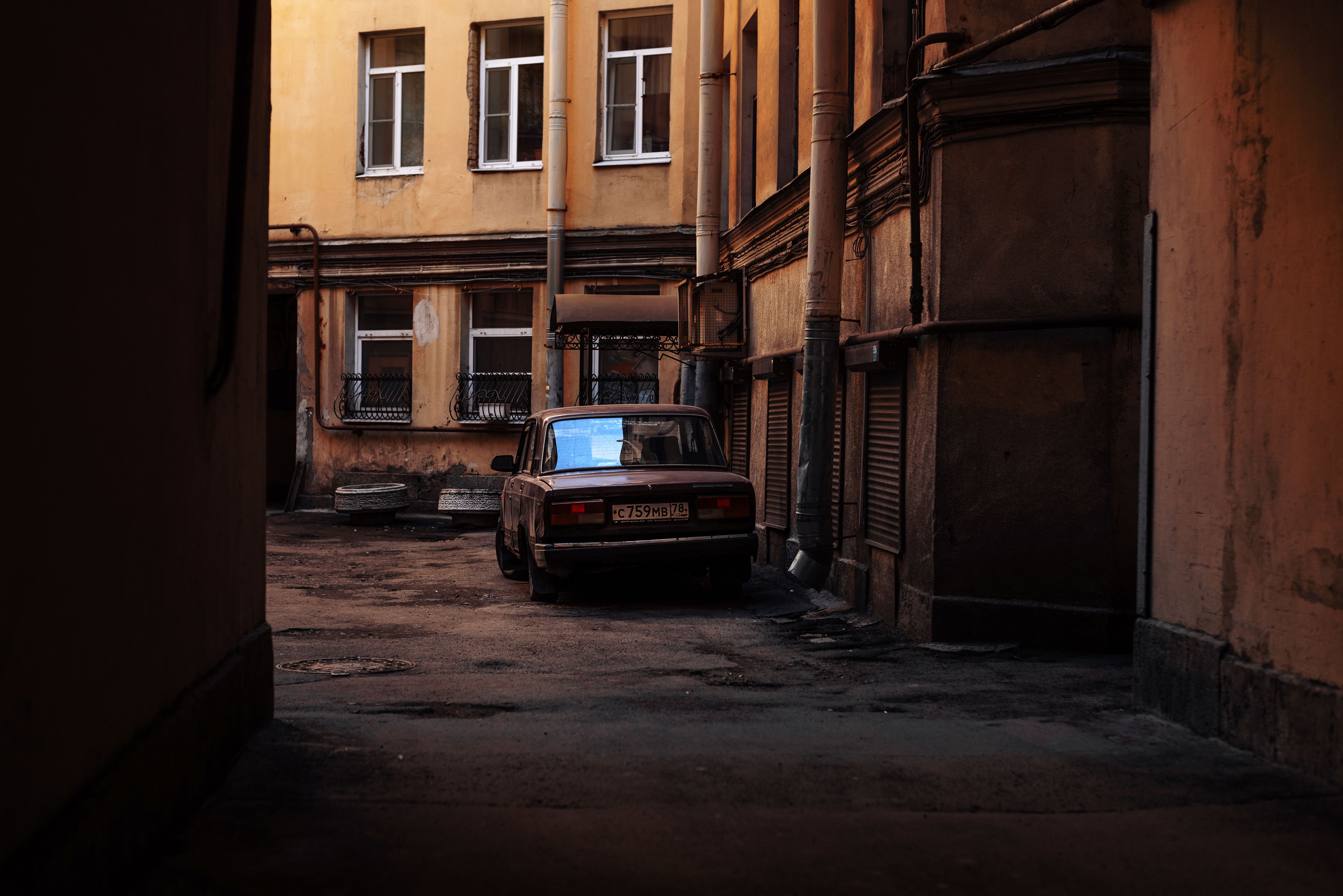 Basketball Basket and Cars Parked in Courtyard · Free Stock Photo