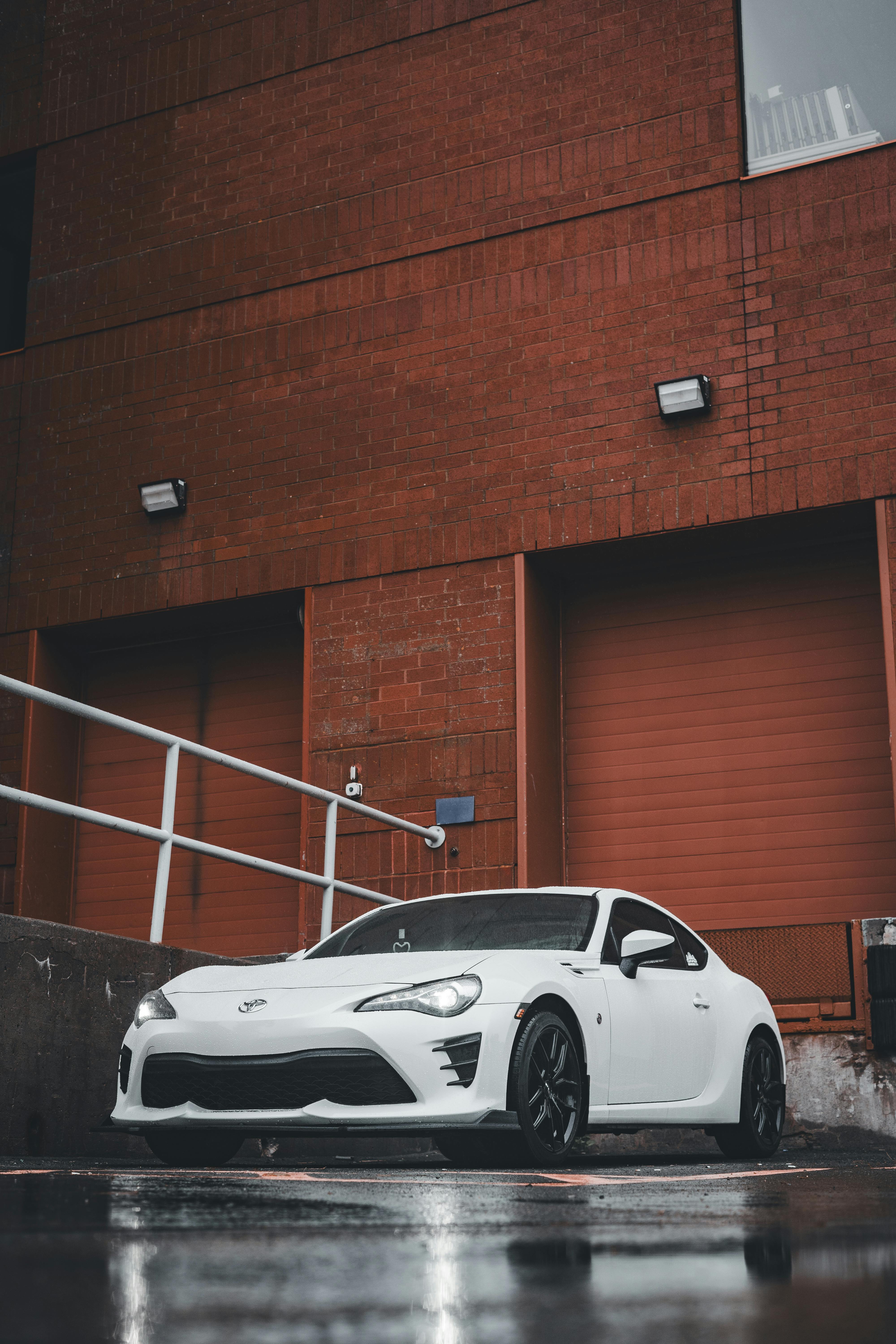 White Toyota Car near Building Wall · Free Stock Photo