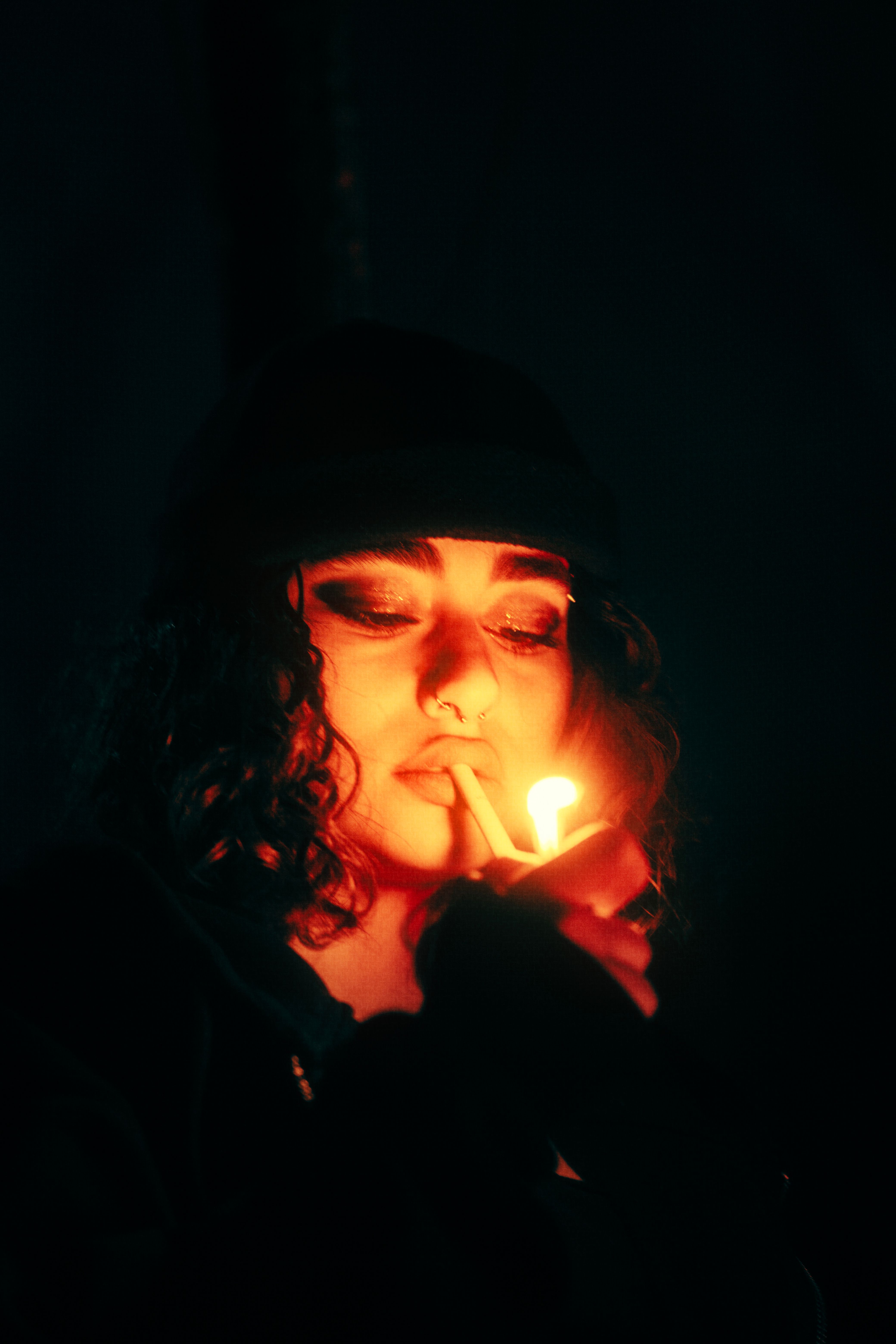 Woman Smoking Cigarette on Balcony Overlooking City and Bay at Night ...