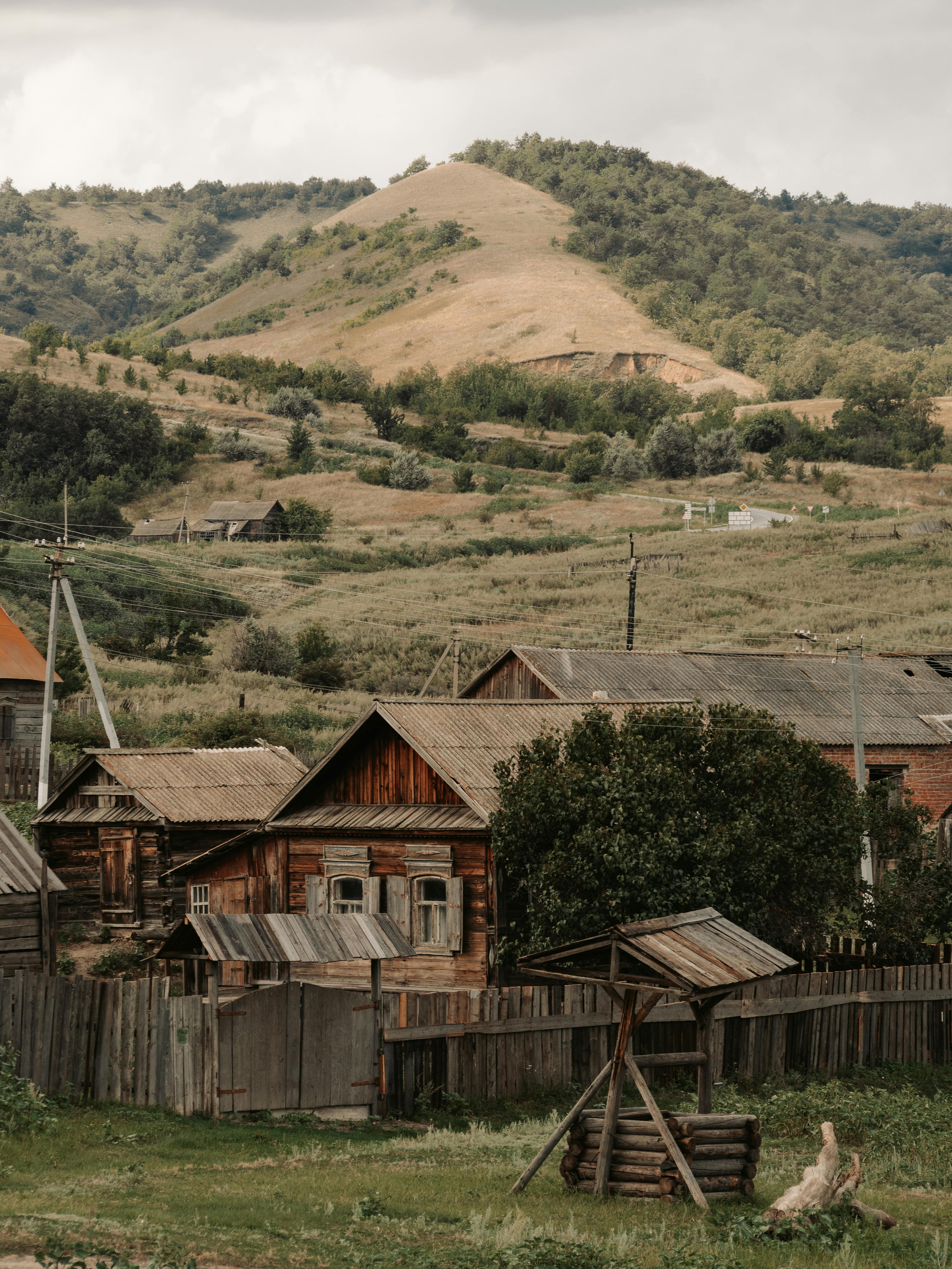 Old Wooden Village House with a Well in a Hilly Landscape · Free Stock ...