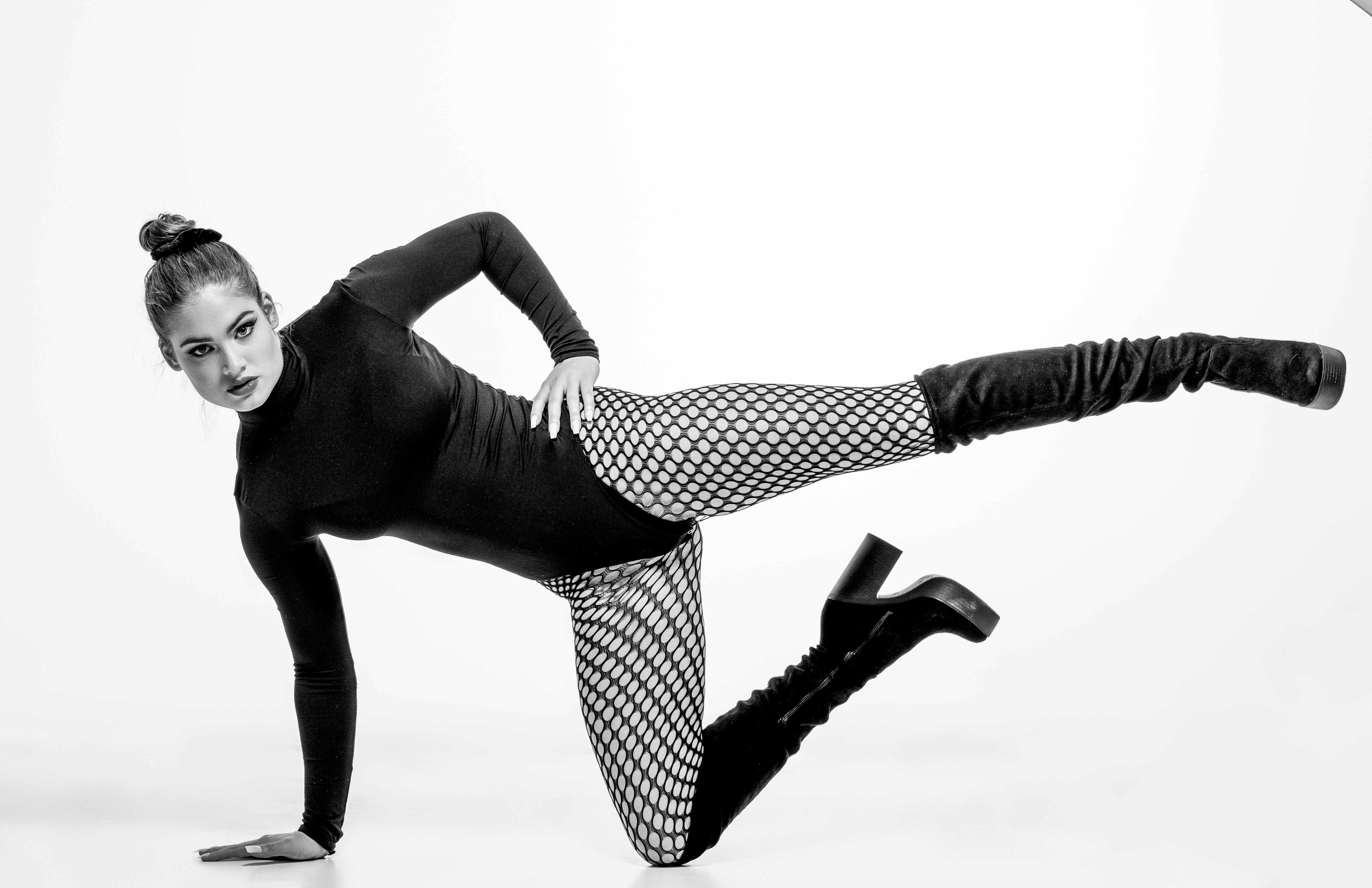 Model Posing in Bodysuit and Boots · Free Stock Photo