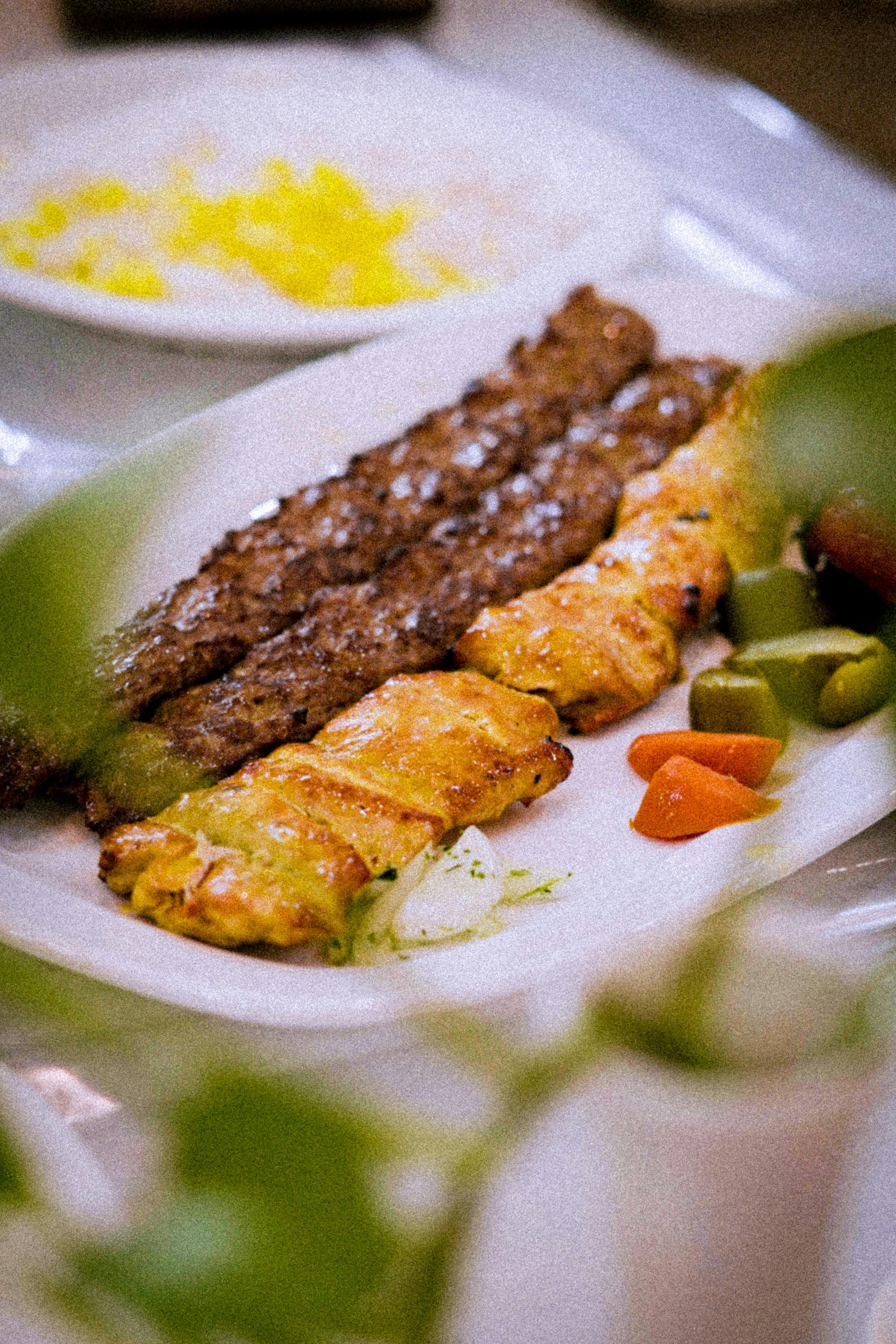 Cook Cutting Meat on a Rotating Spit to Prepare Shawarma · Free Stock Photo