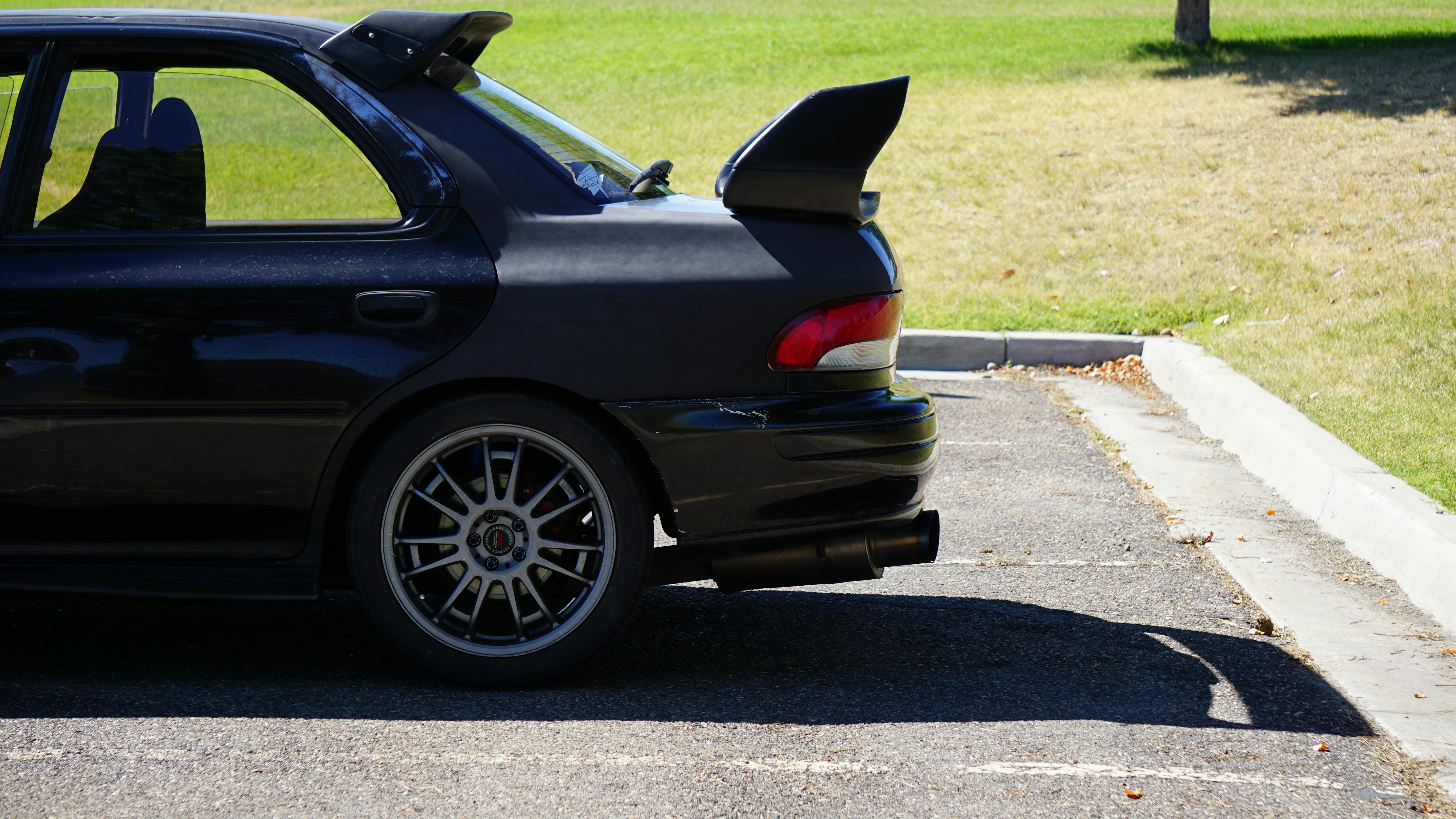 Side View of a Black Vintage Subaru Impreza · Free Stock Photo