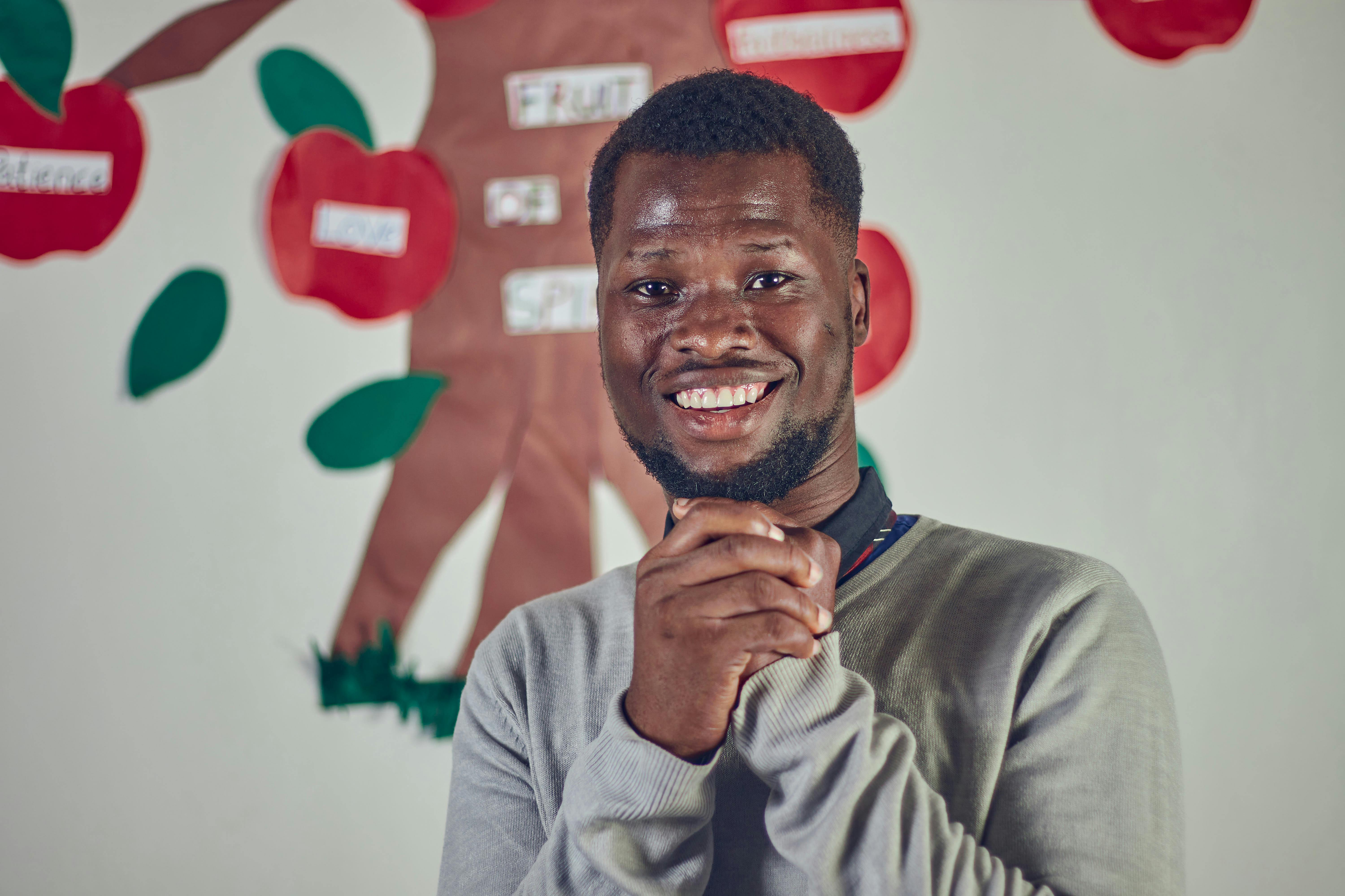 African Man in Front of Child Paintings · Free Stock Photo