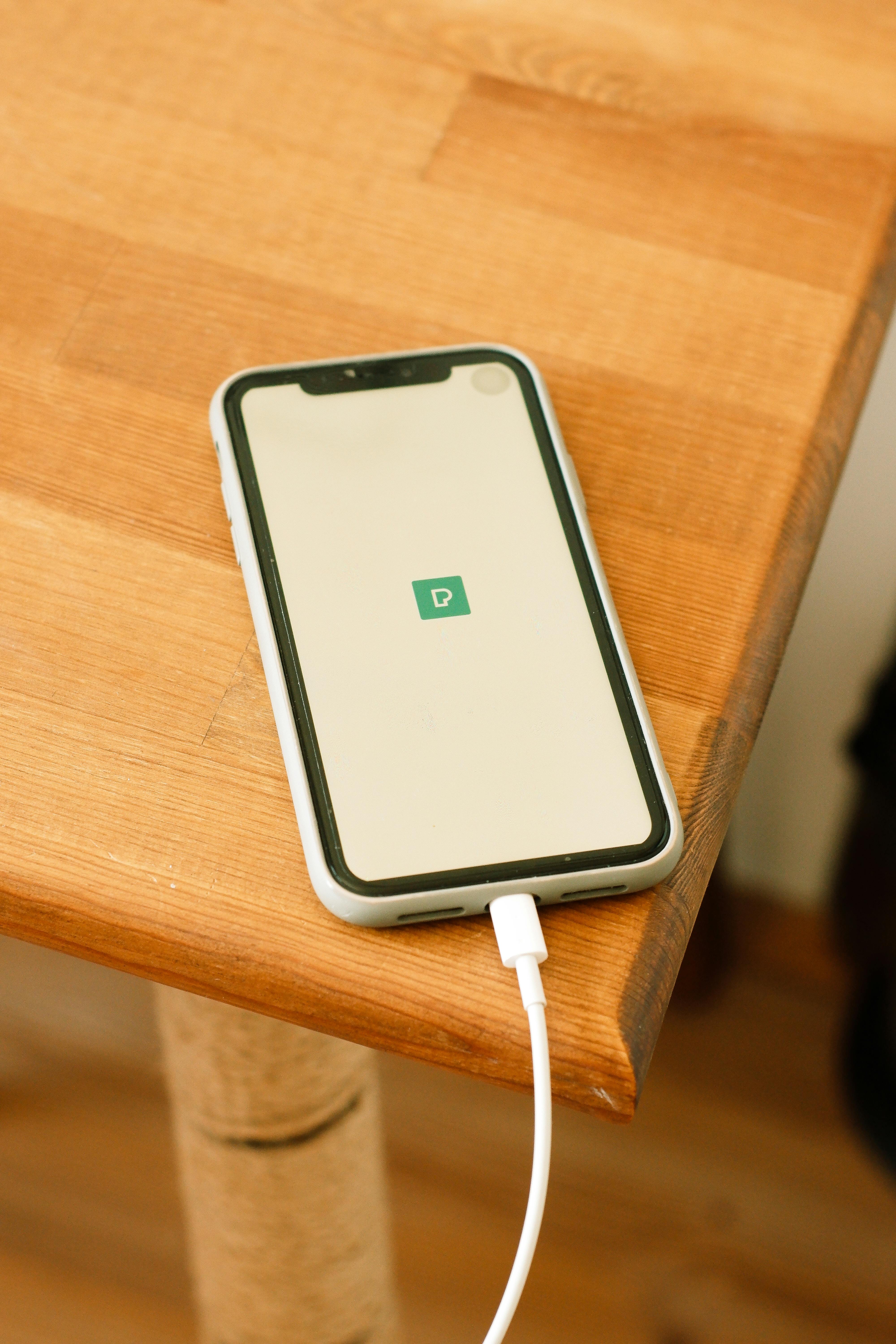 Phone Charging on a Table · Free Stock Photo