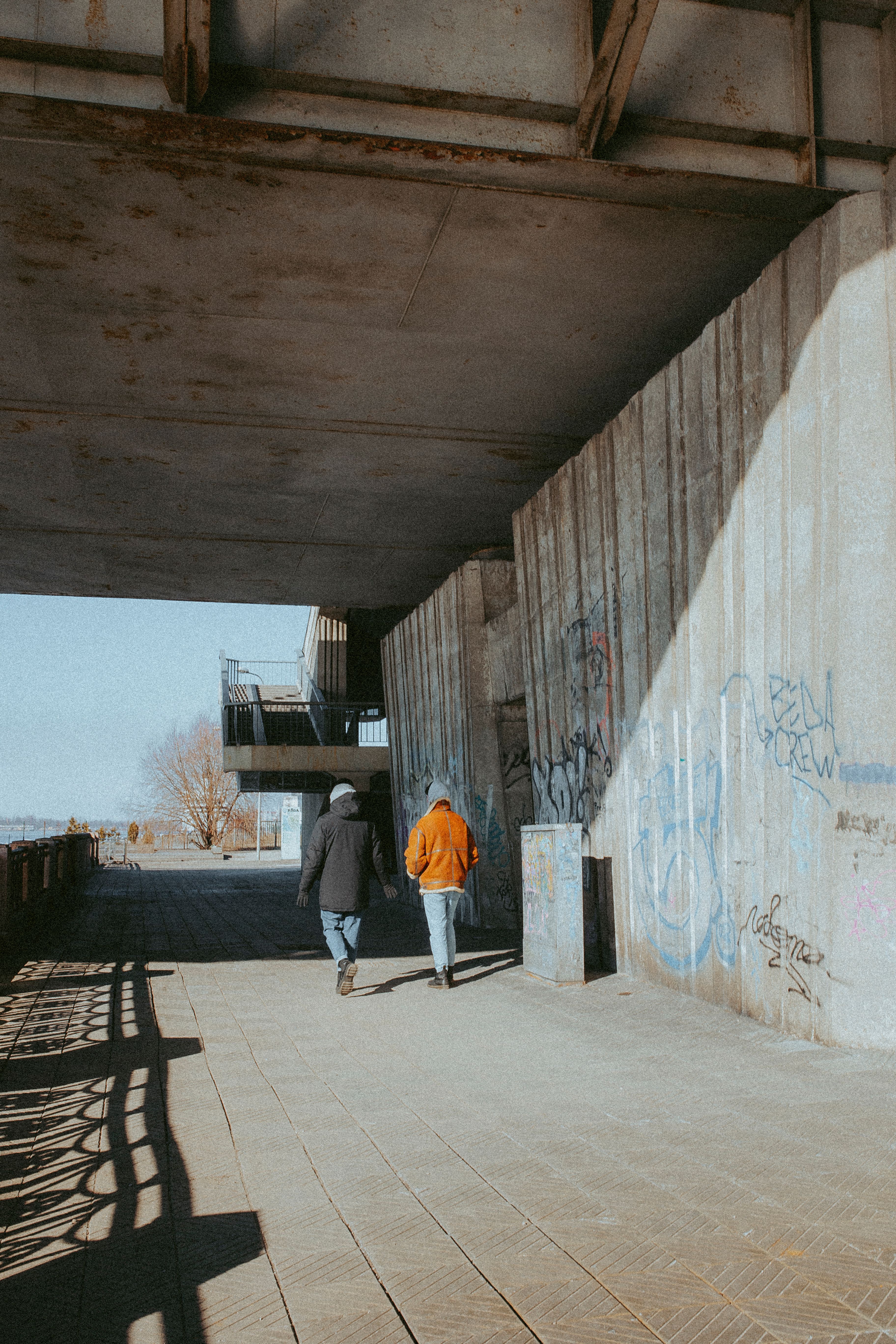Two Man Walking under the Bridge · Free Stock Photo