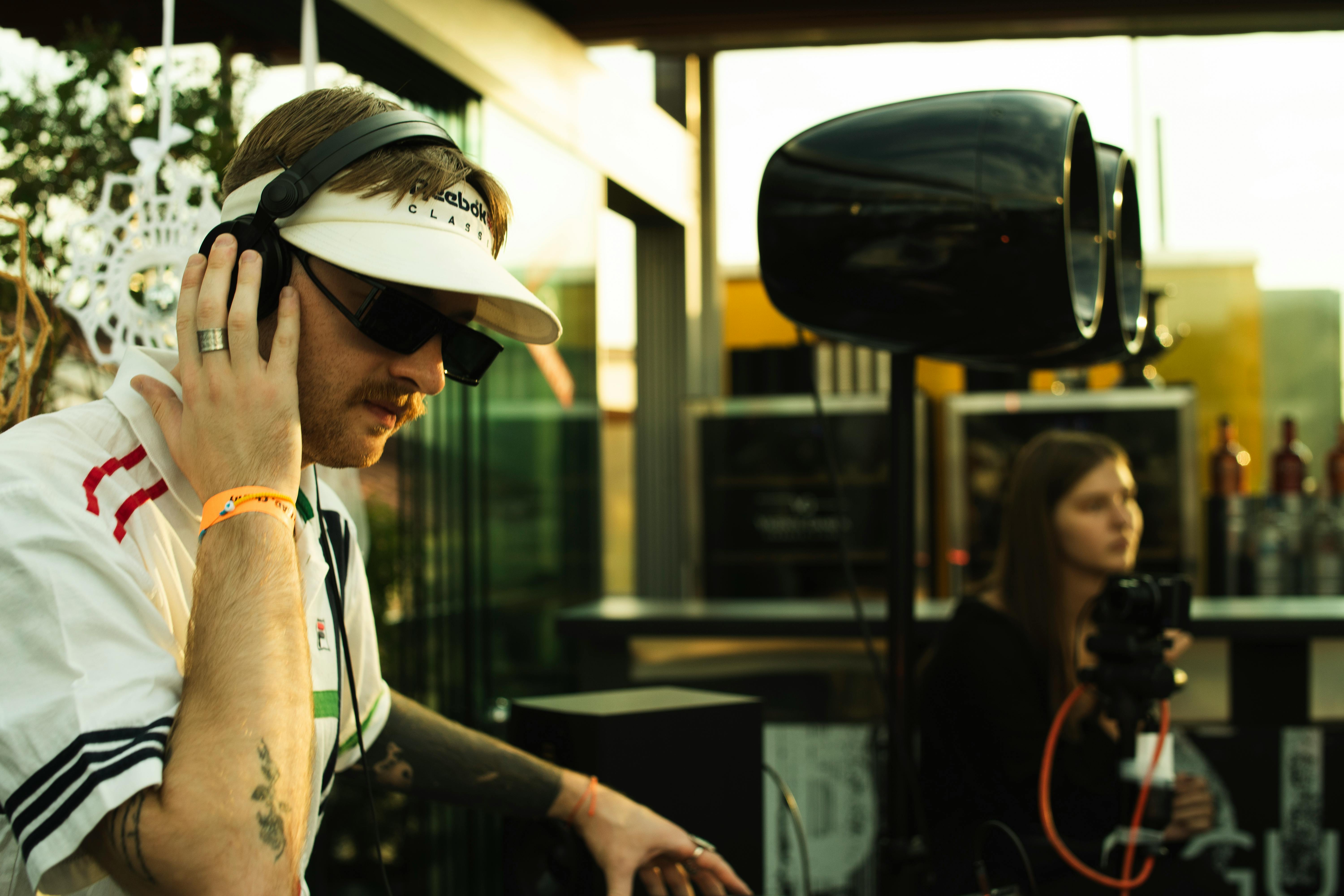 DJ in Cap and Headphones · Free Stock Photo