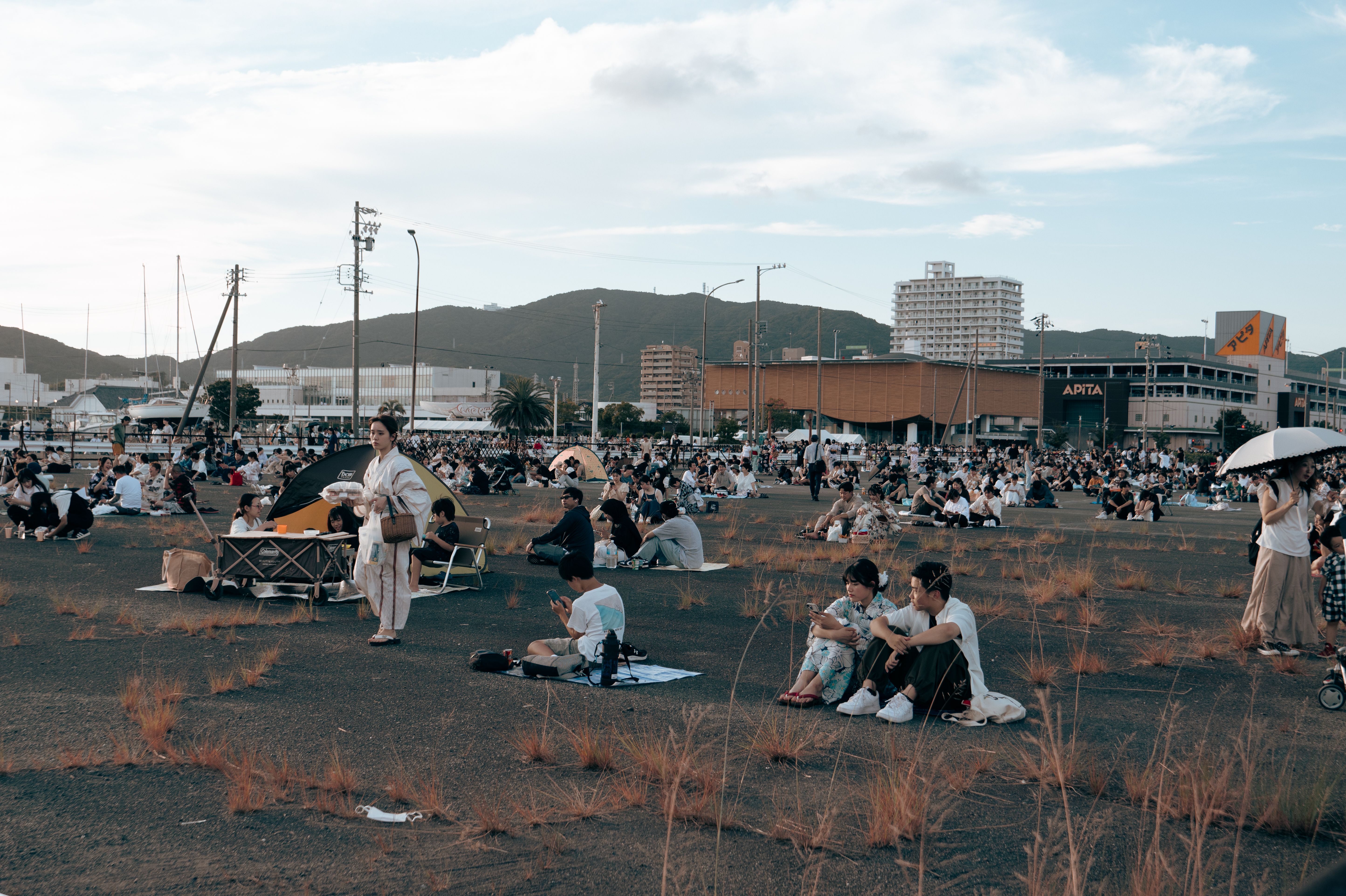 People Sitting on Ground in City · Free Stock Photo
