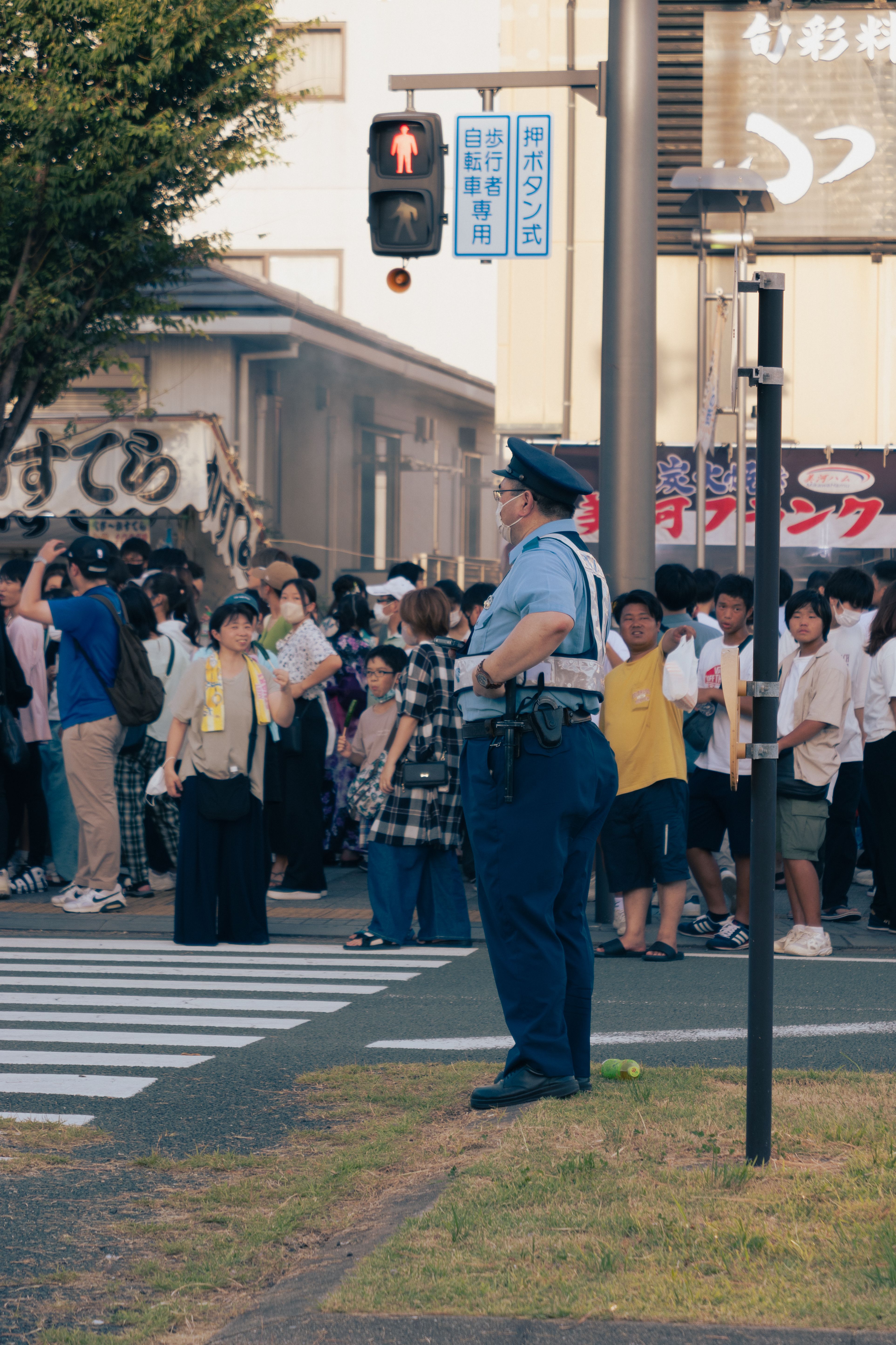 A police officer stands on a street corner in japan · Free Stock Photo
