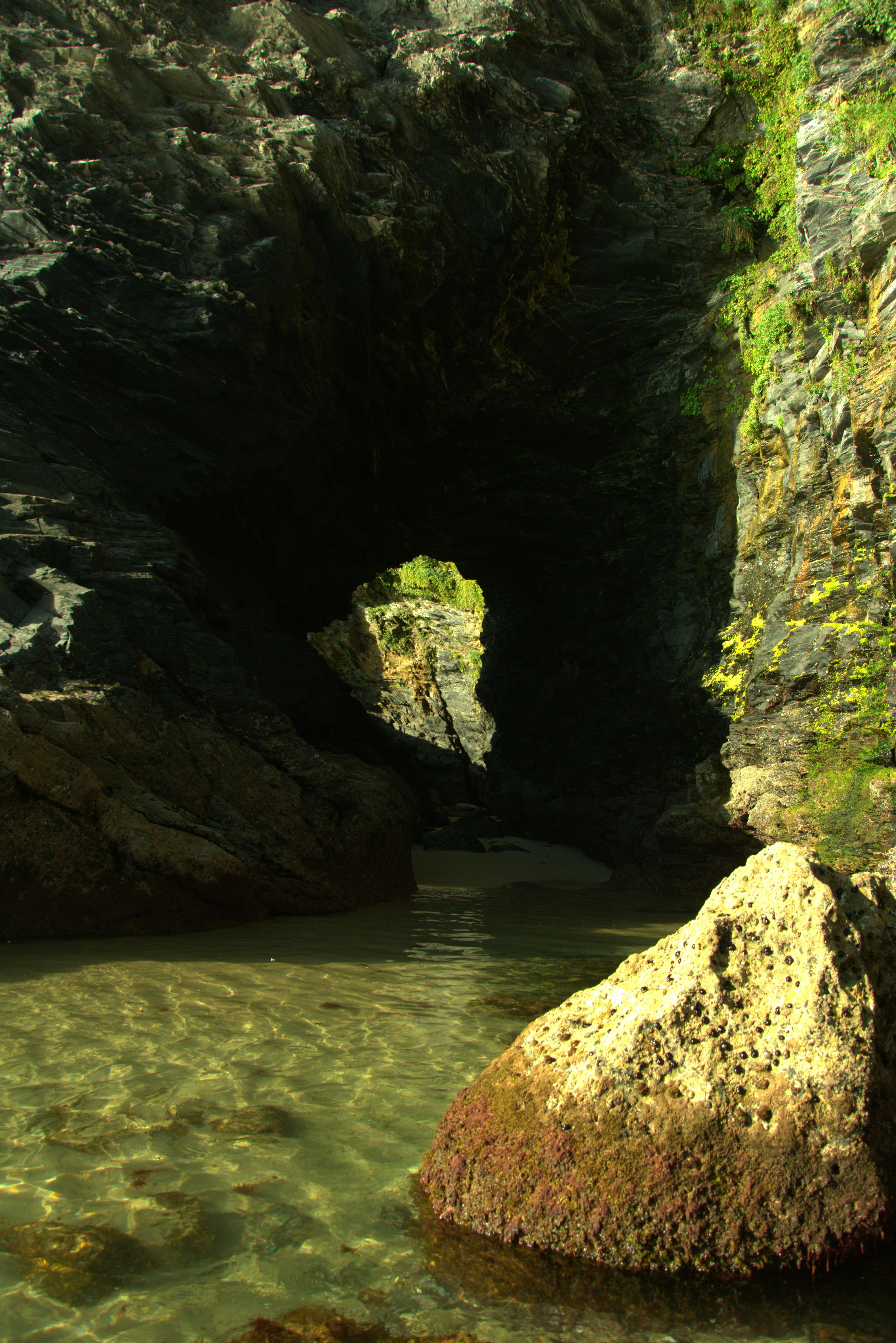 A Man Standing in the Middle of the Cave Surrounded with Water · Free ...