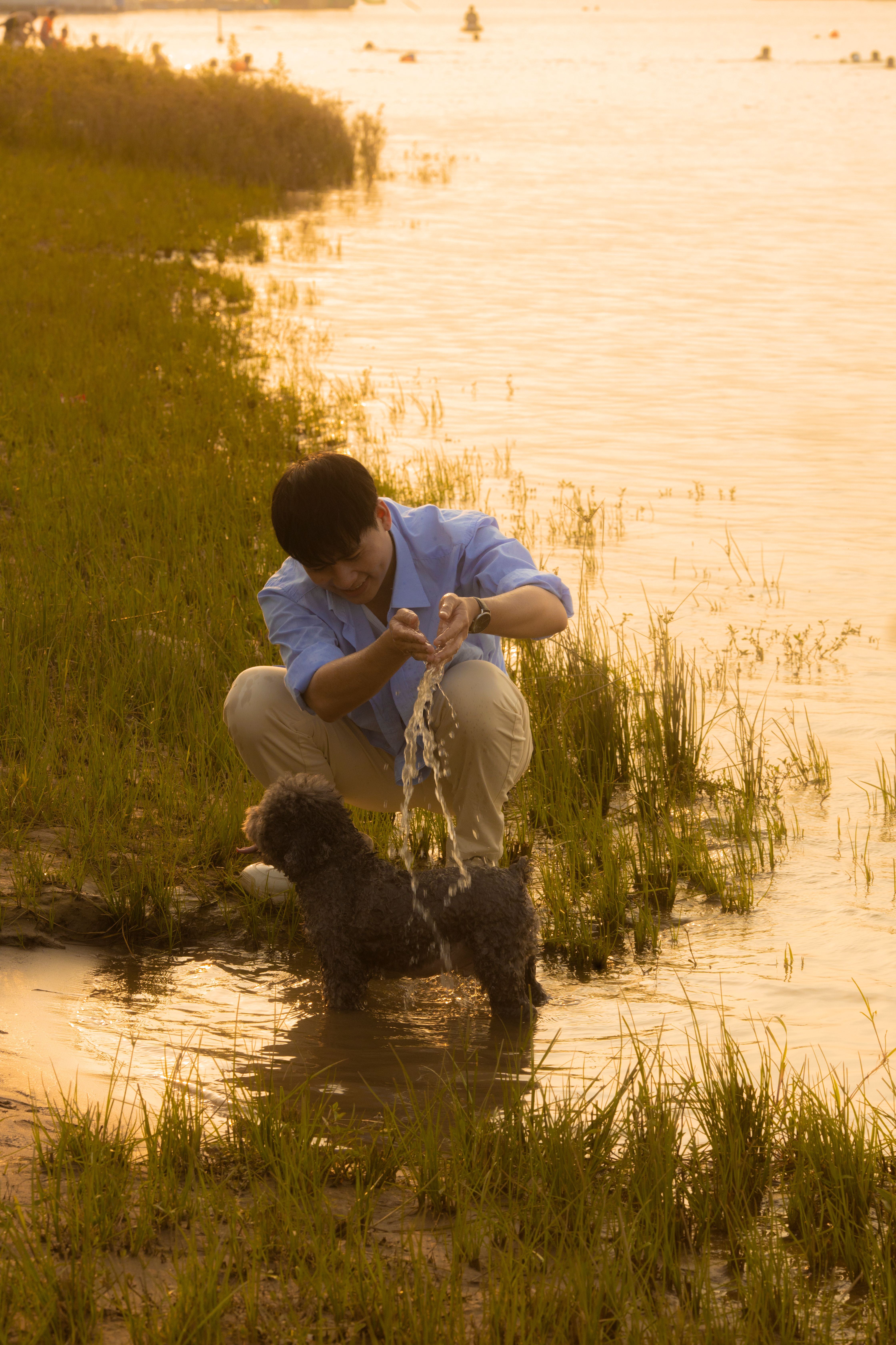 Person with Long Hair Squatting by Water · Free Stock Photo