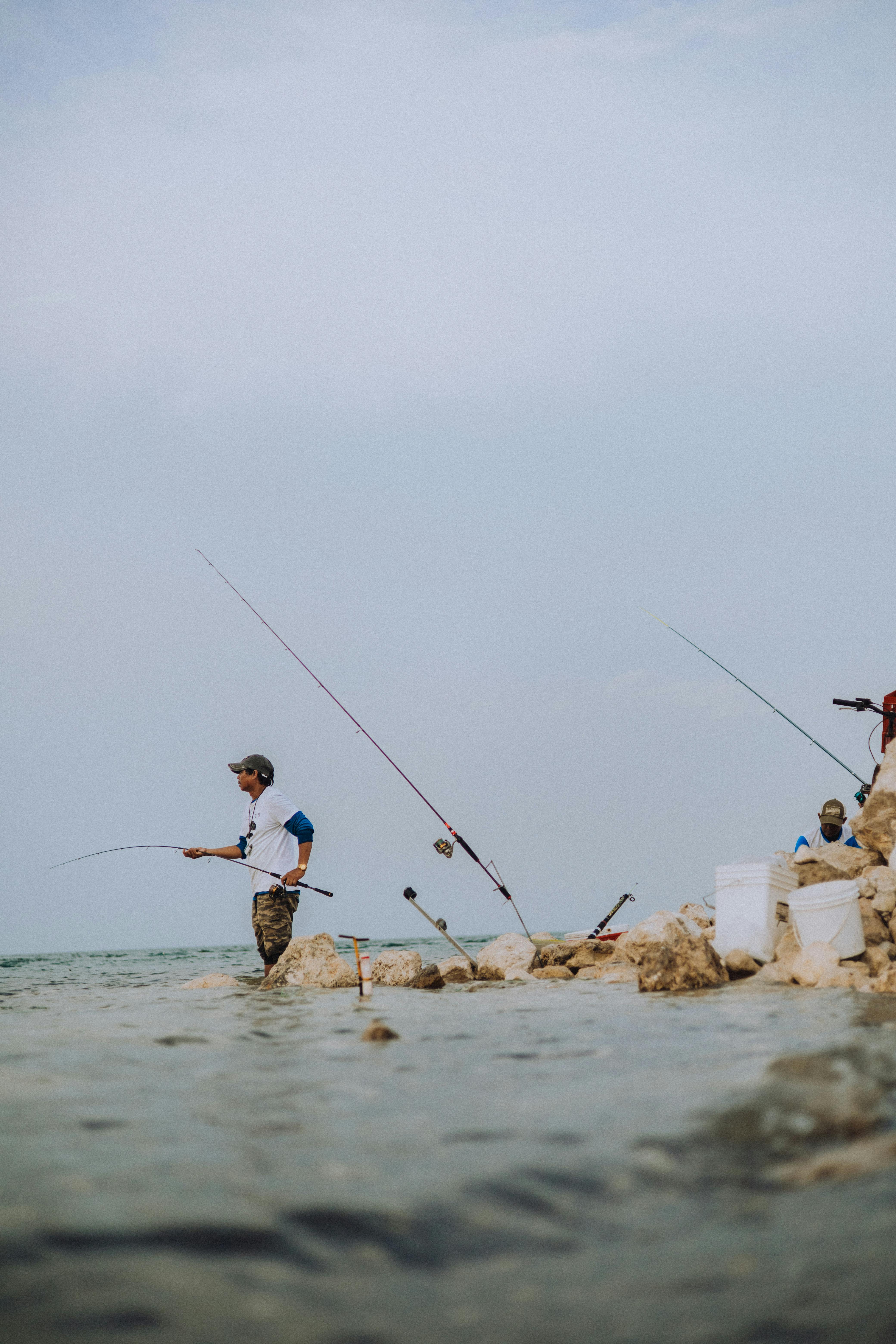 Man Fishing on Sea Shore · Free Stock Photo