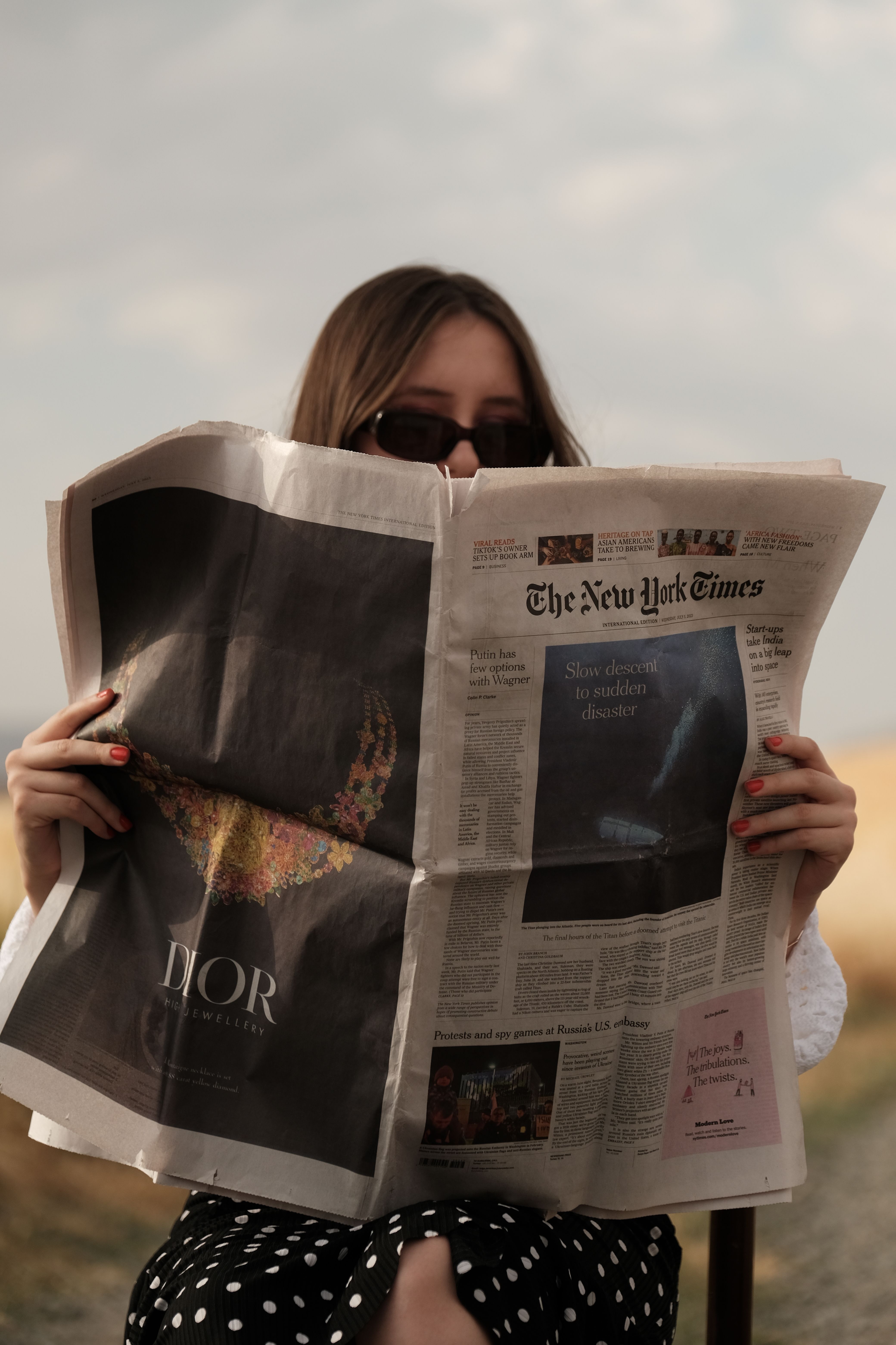 Woman in Spotted Dress Reading Newspaper · Free Stock Photo